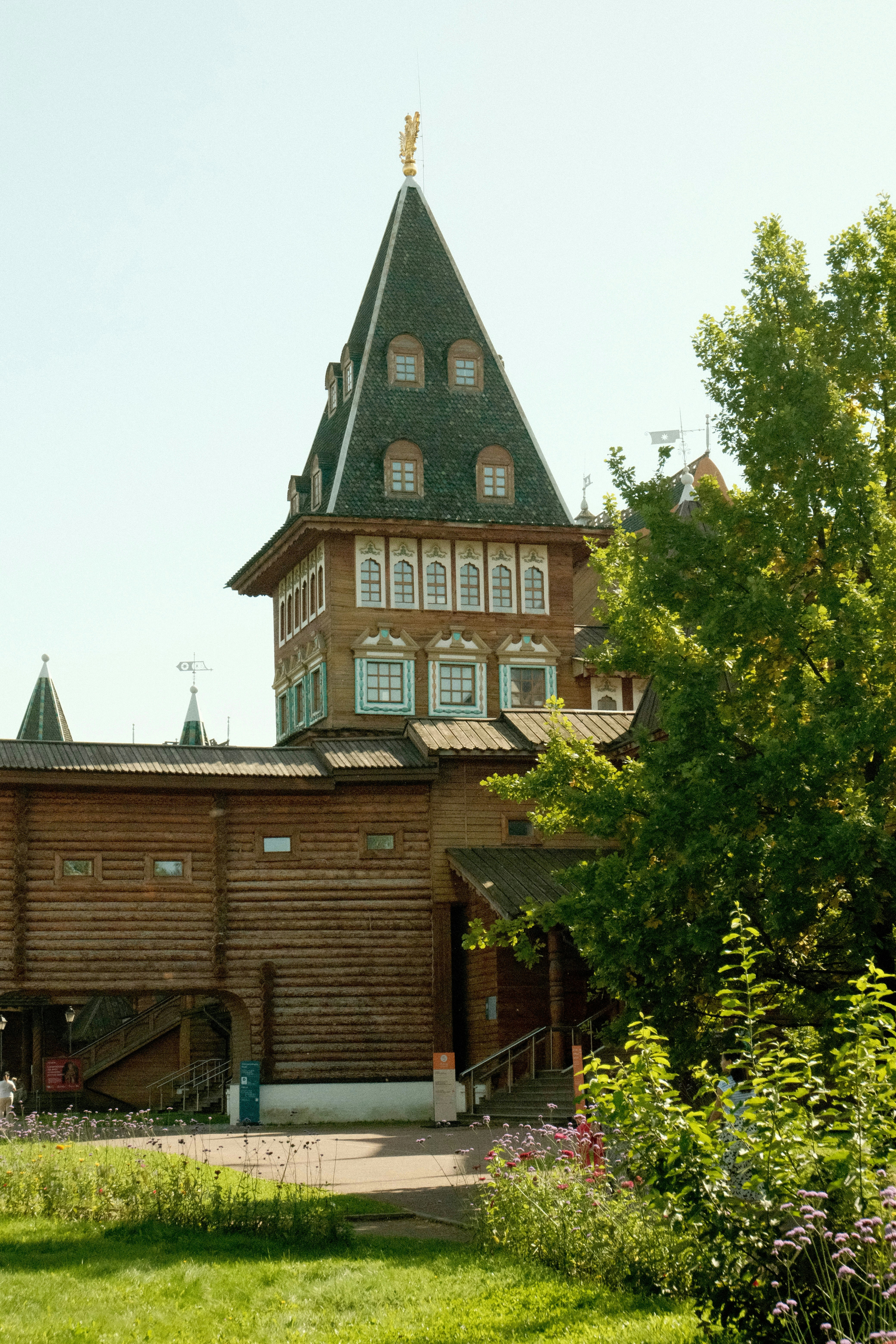 Wooden palace tower with green roof and windows