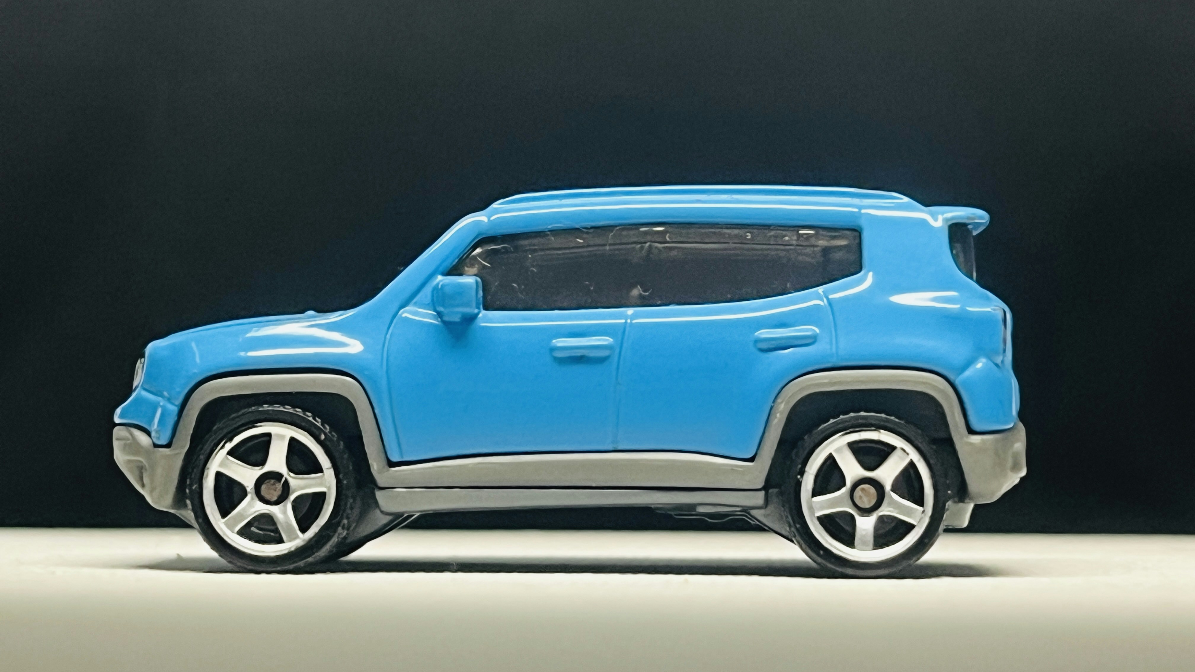 Matchbox 2019 Jeep Renegade | A blue toy suv parked on a surface.
