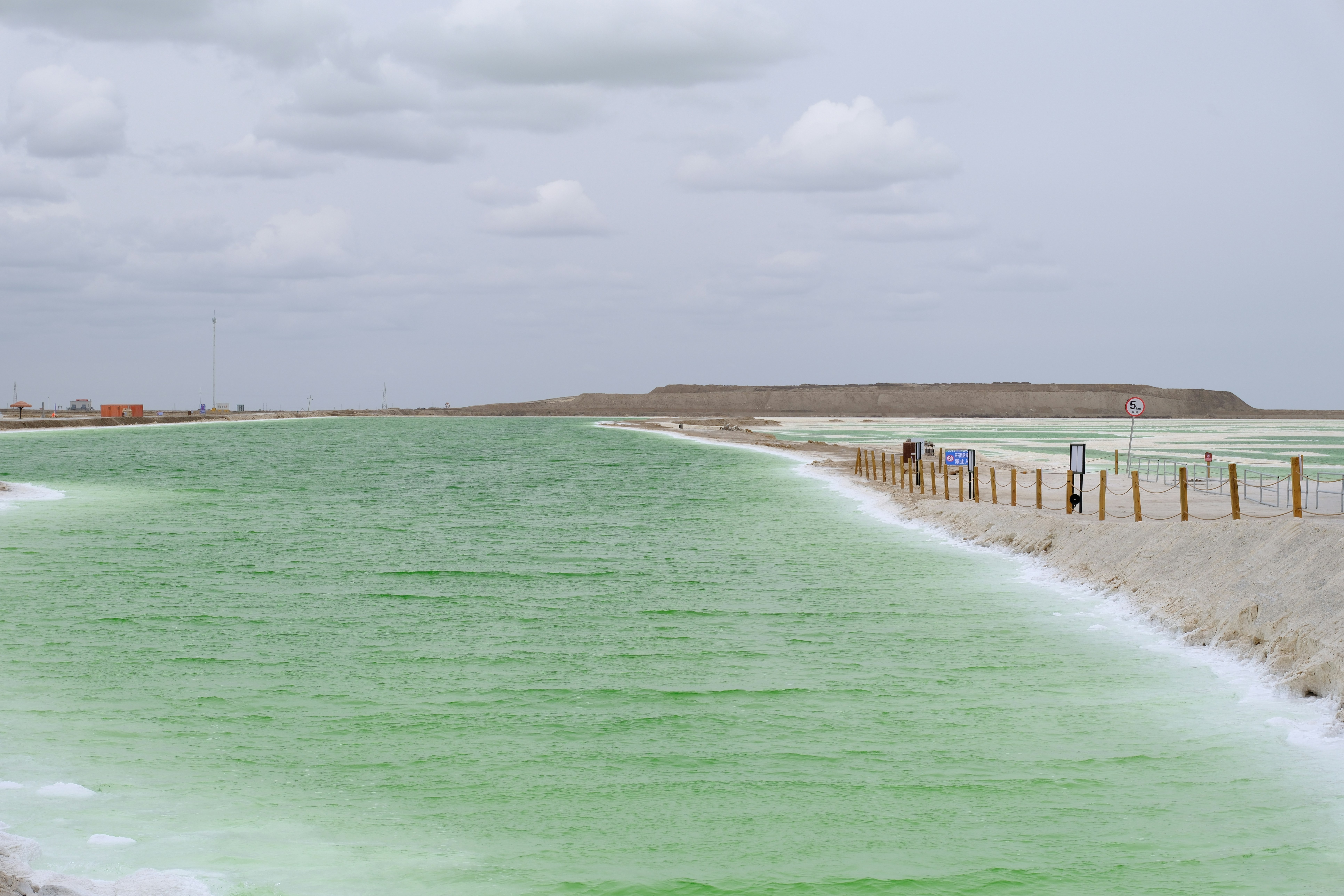 Emerald Channel Curving Toward a Distant Barrier