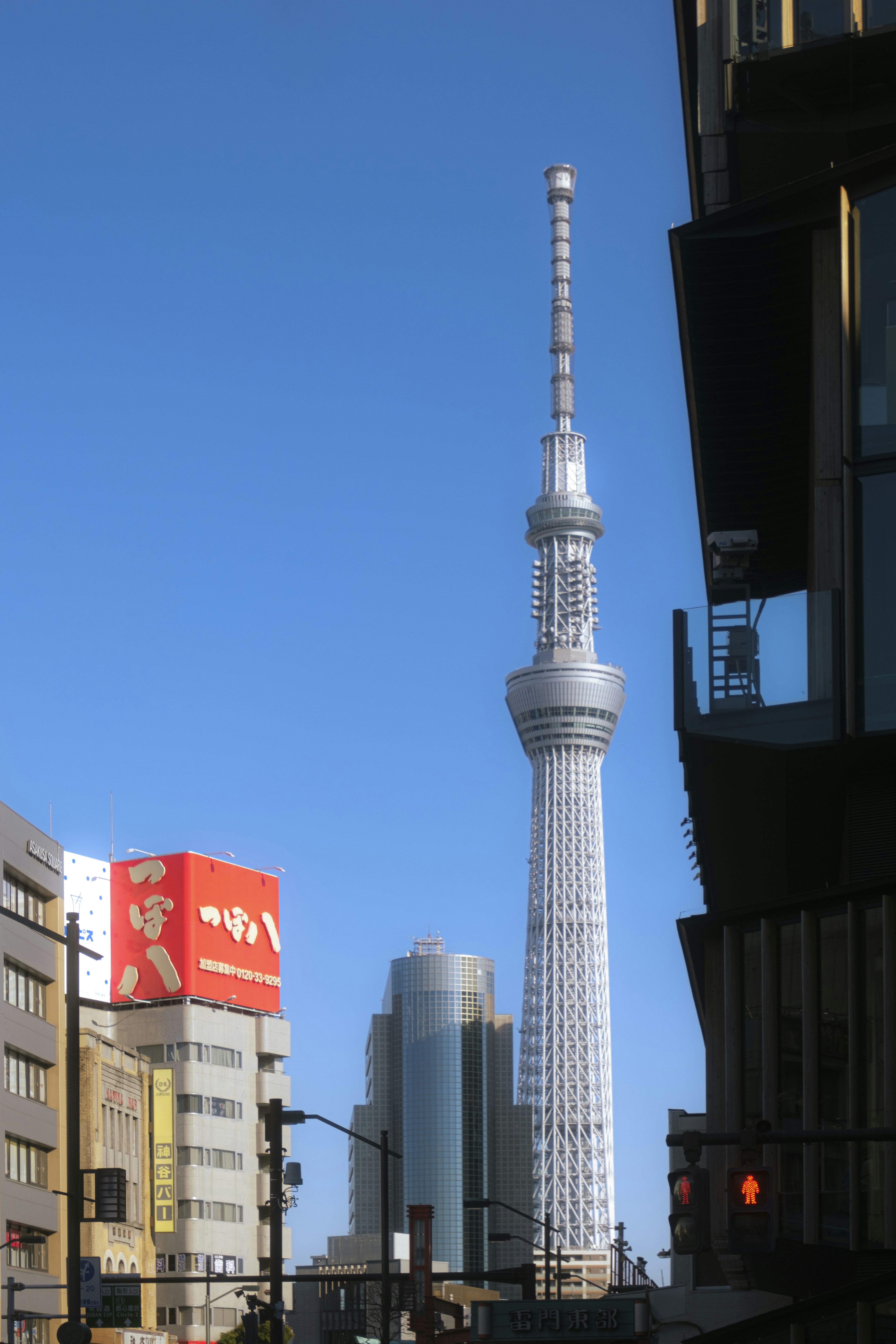 Tall modern skyscraper against a clear blue sky.