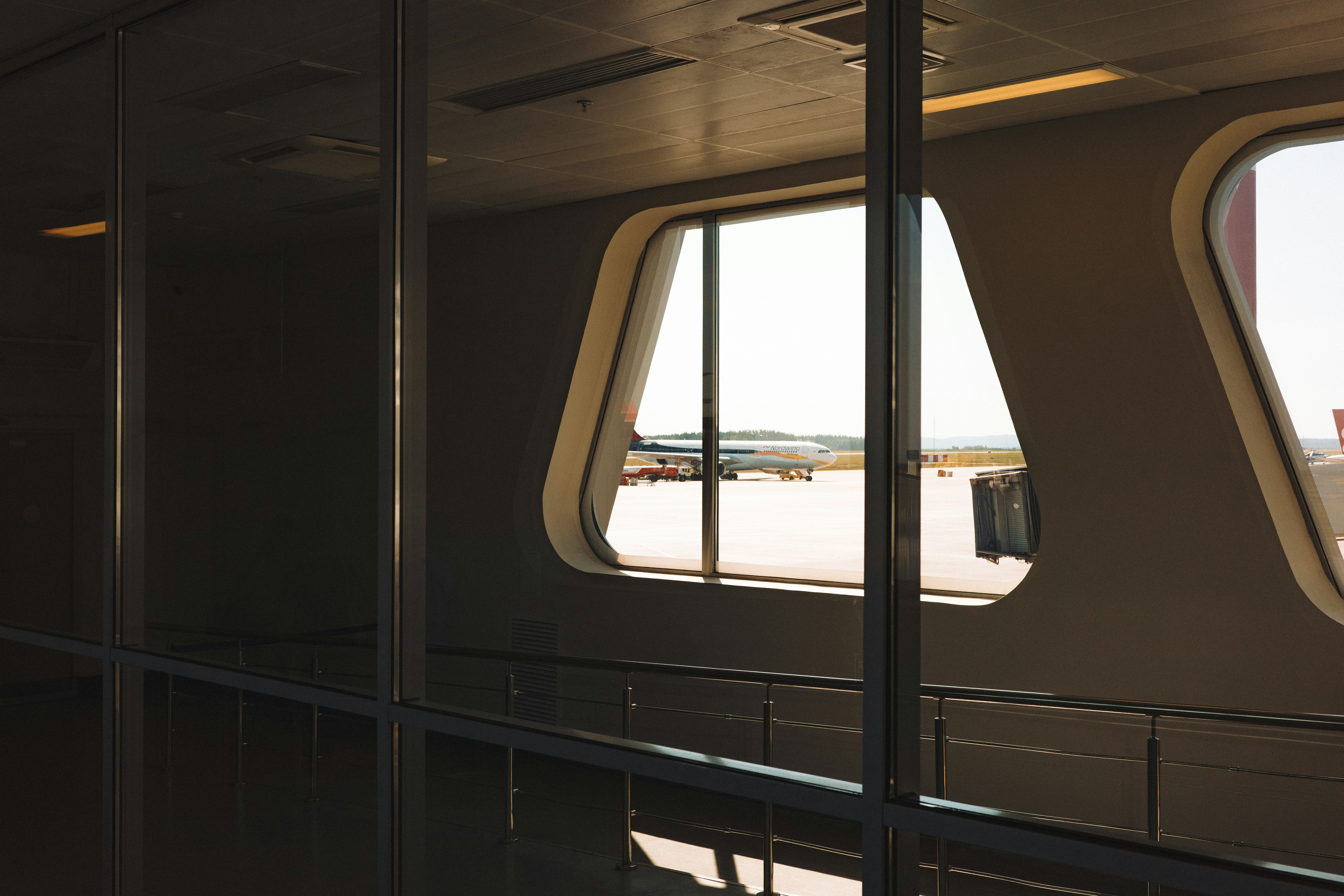 Framed Light: Runway View Through Jet Bridge Grids