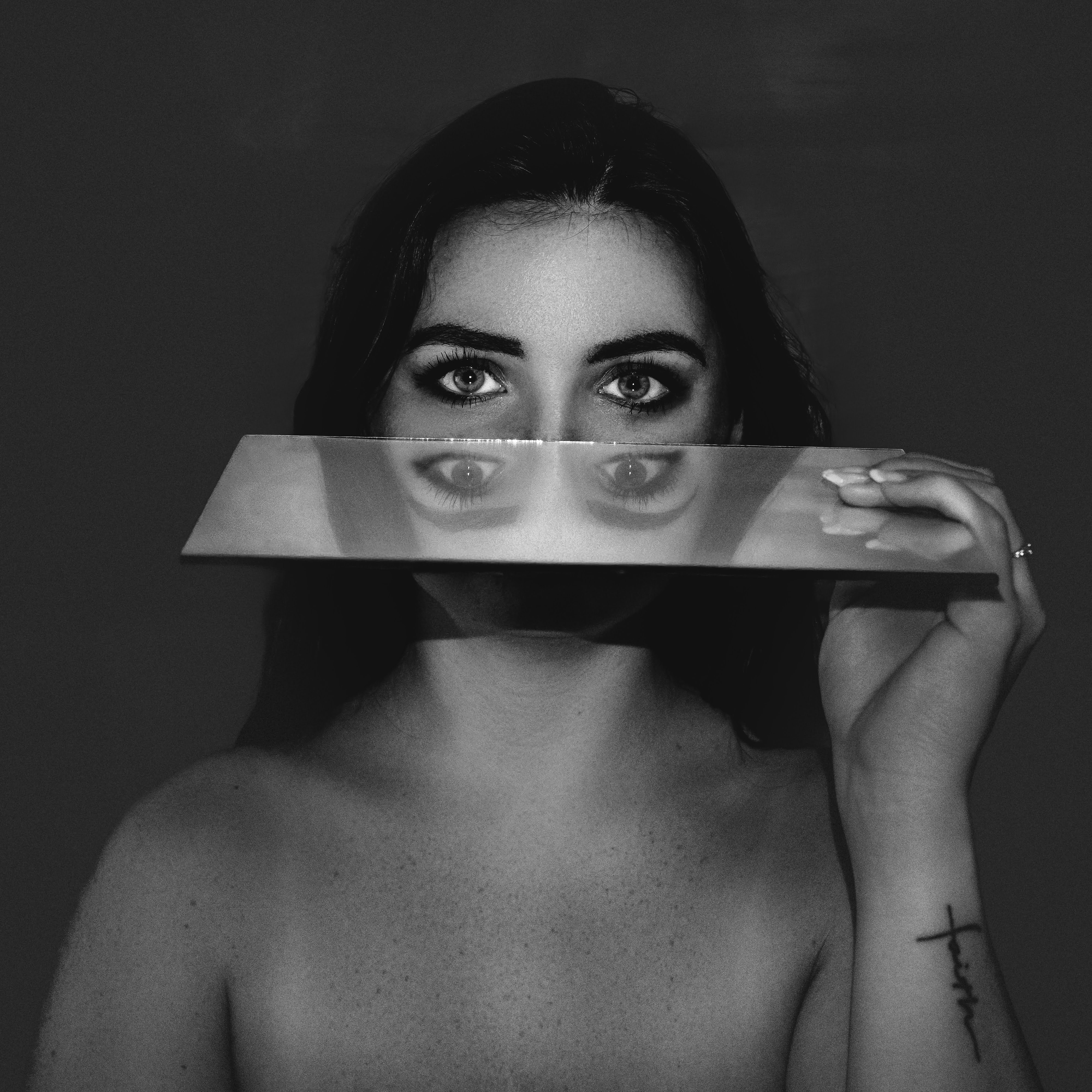 Woman holding a mirror reflecting her eyes