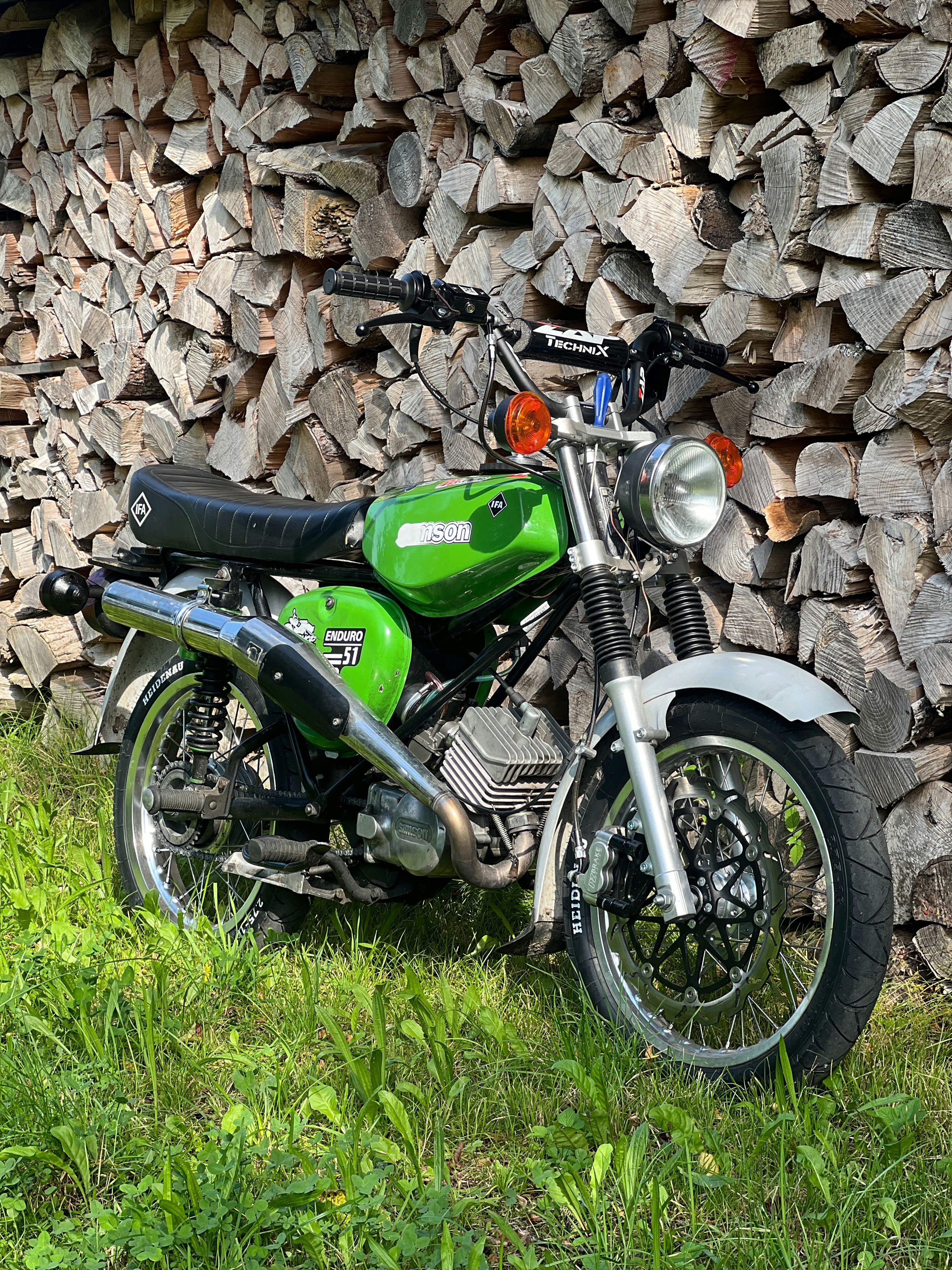Reviving the Classic: A Green Moped in Nature's Embrace