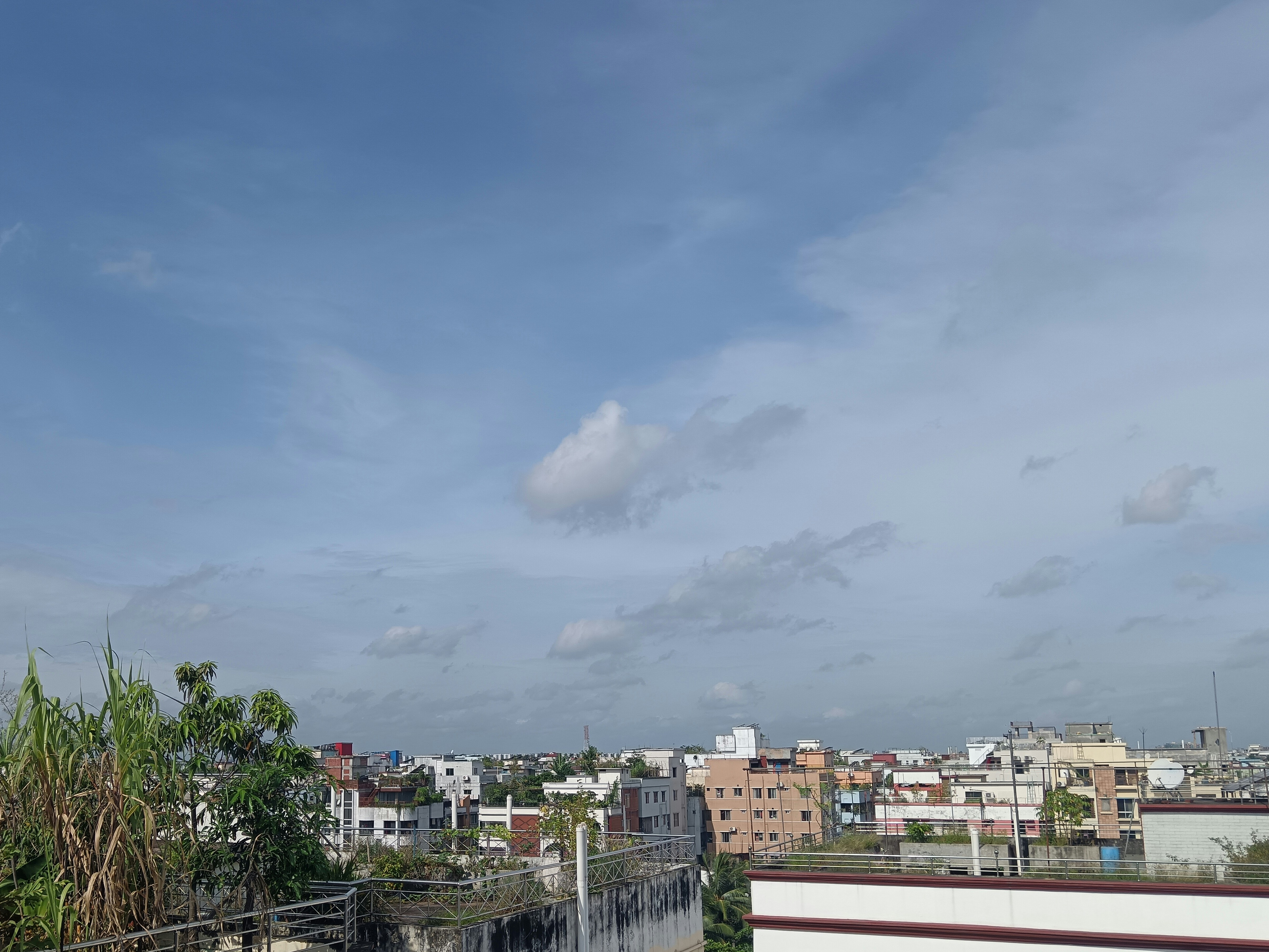 Cityscape with buildings under a cloudy blue sky