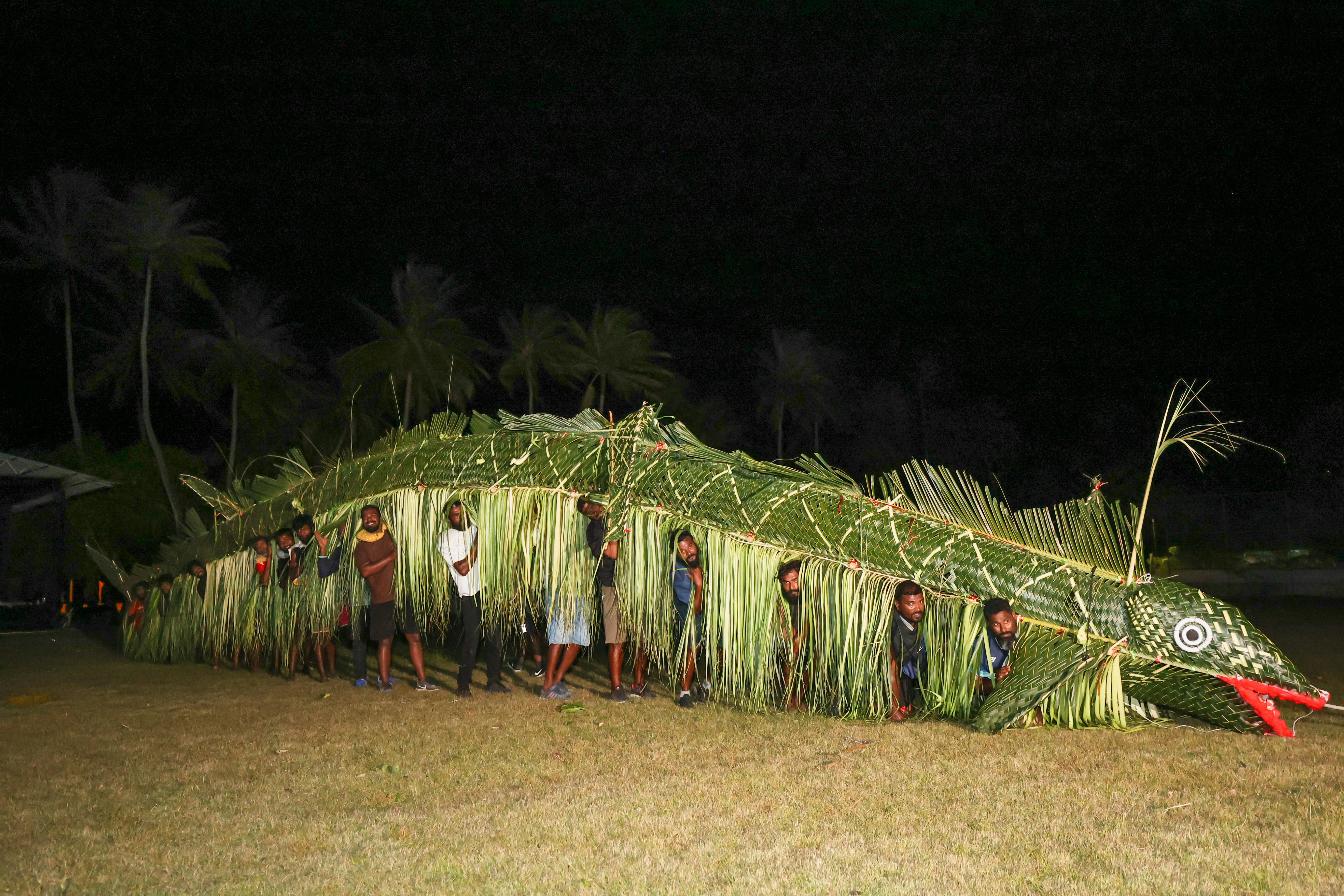 Nighttime Parade Under a Panicked Palm-Cilled Monster