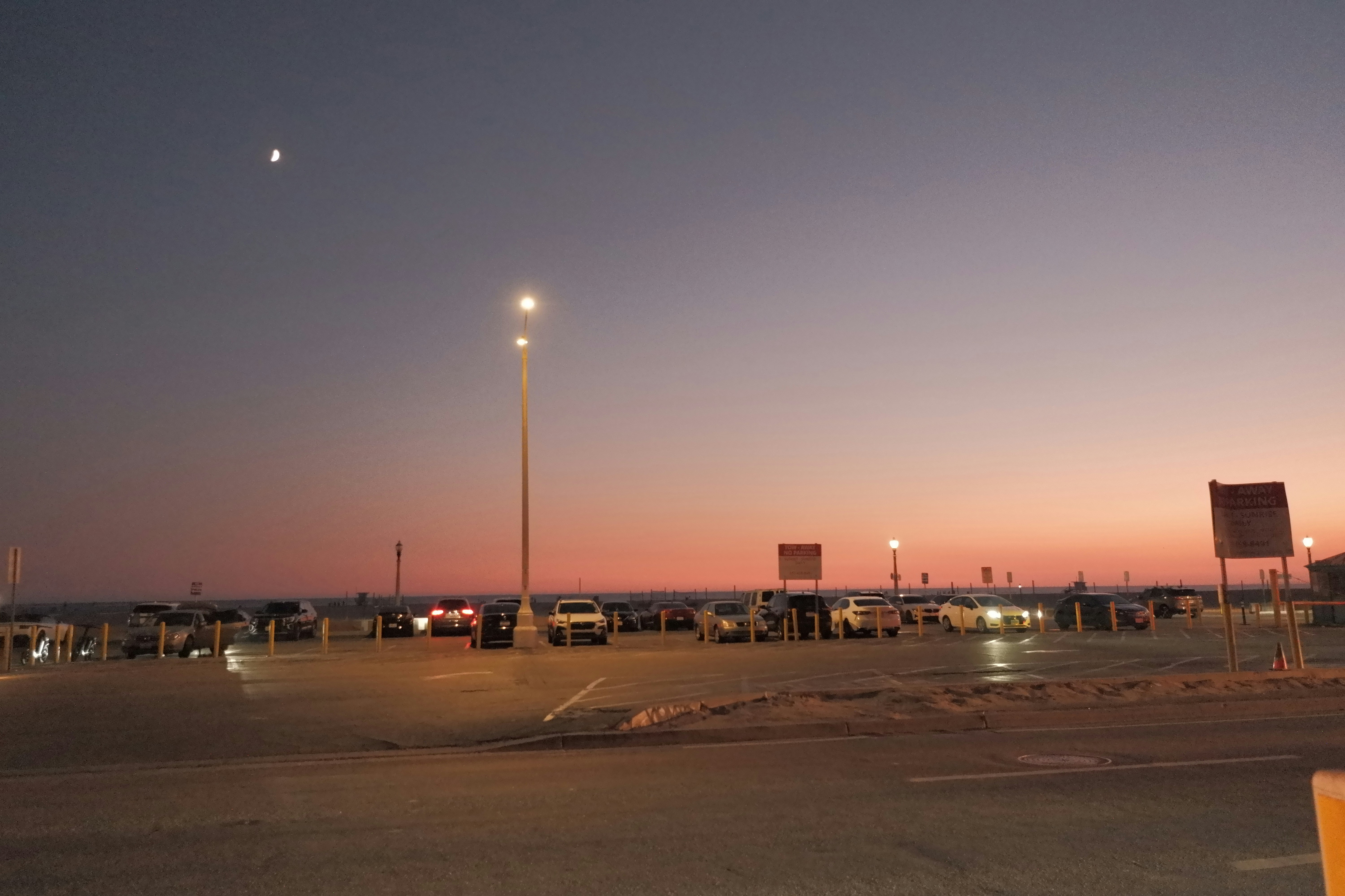 Parking lot at dusk with a colorful sky