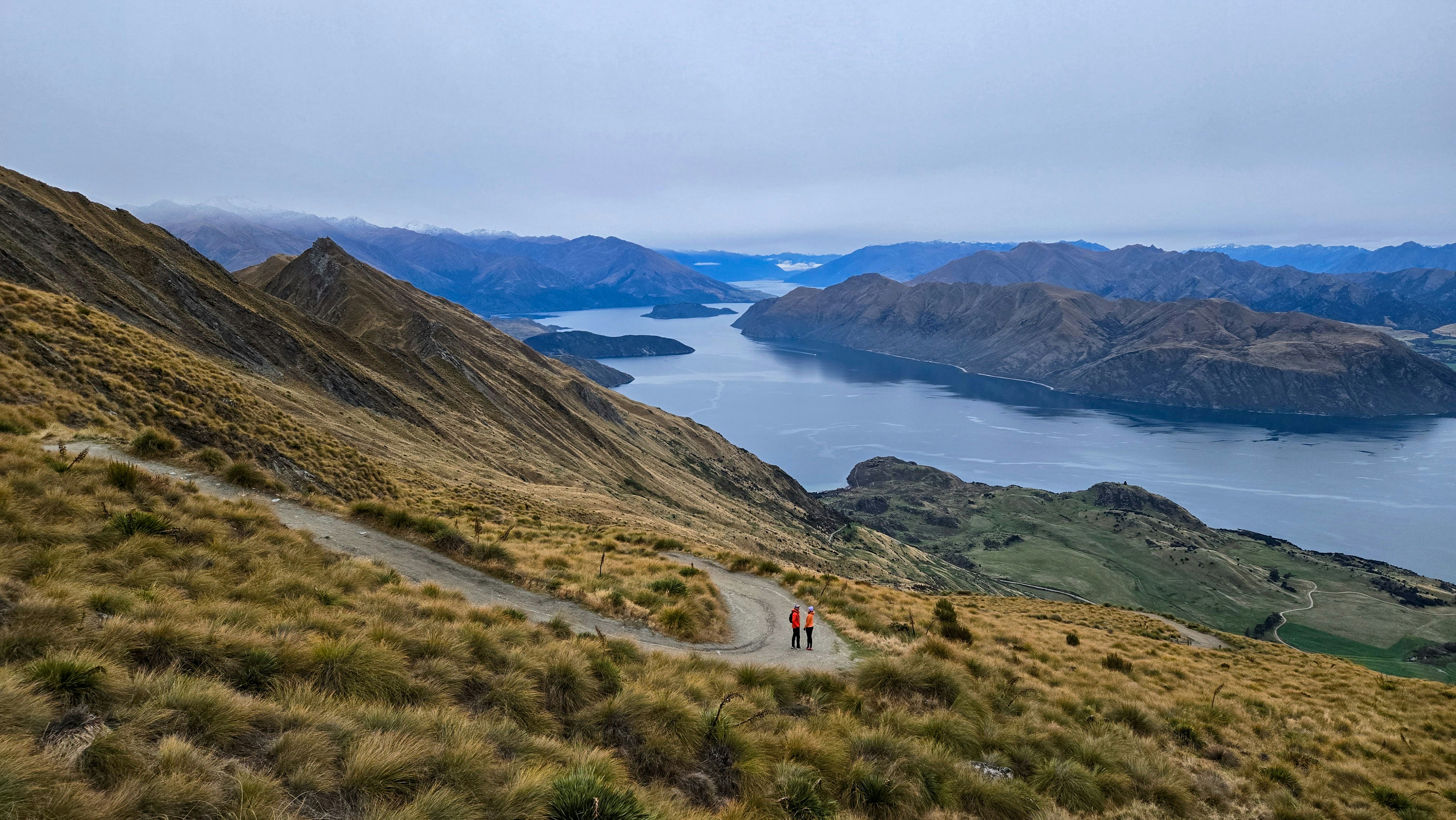 Hikers on a mountain trail overlooking a lake