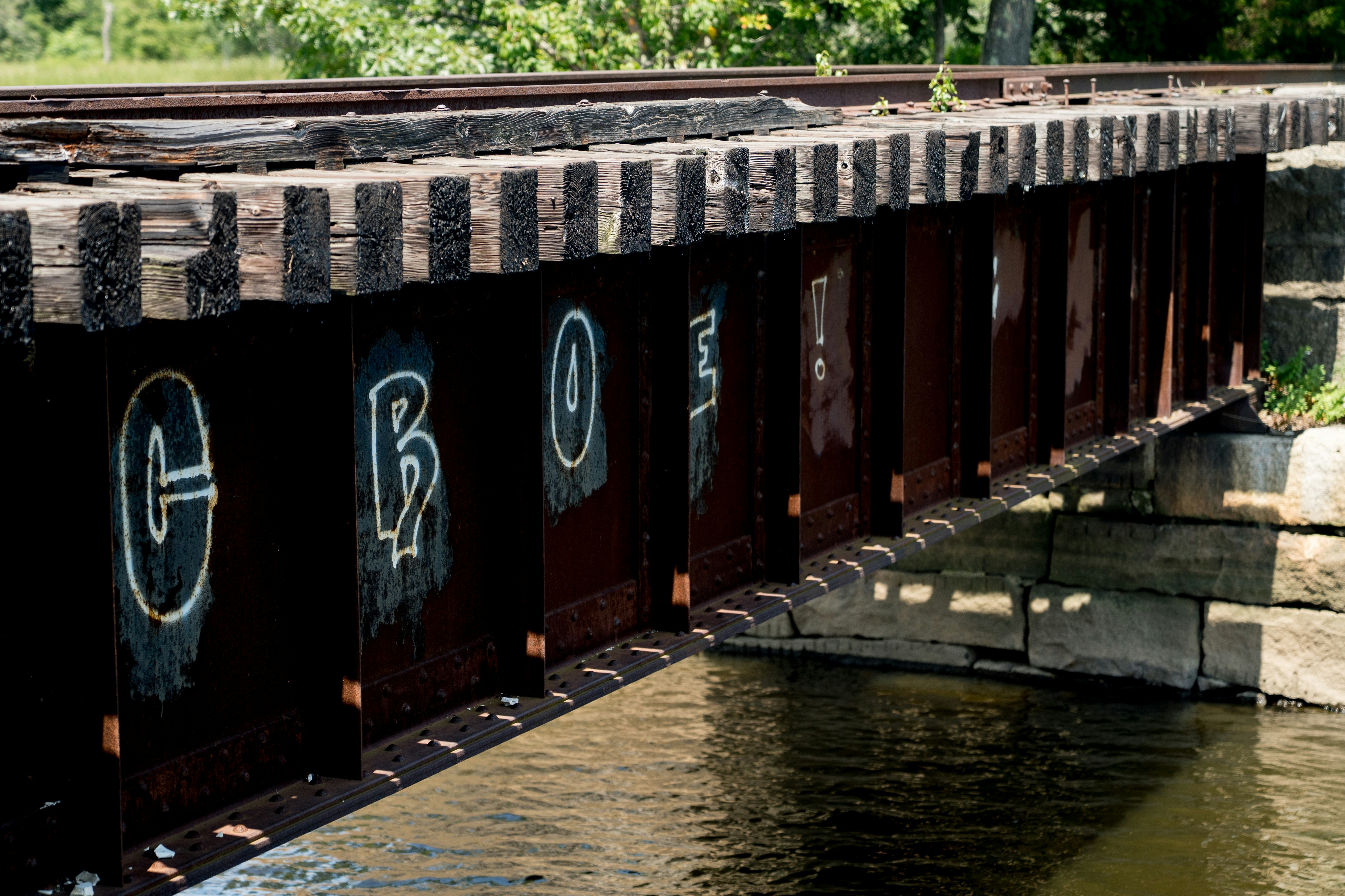 Old railway bridge over a calm river