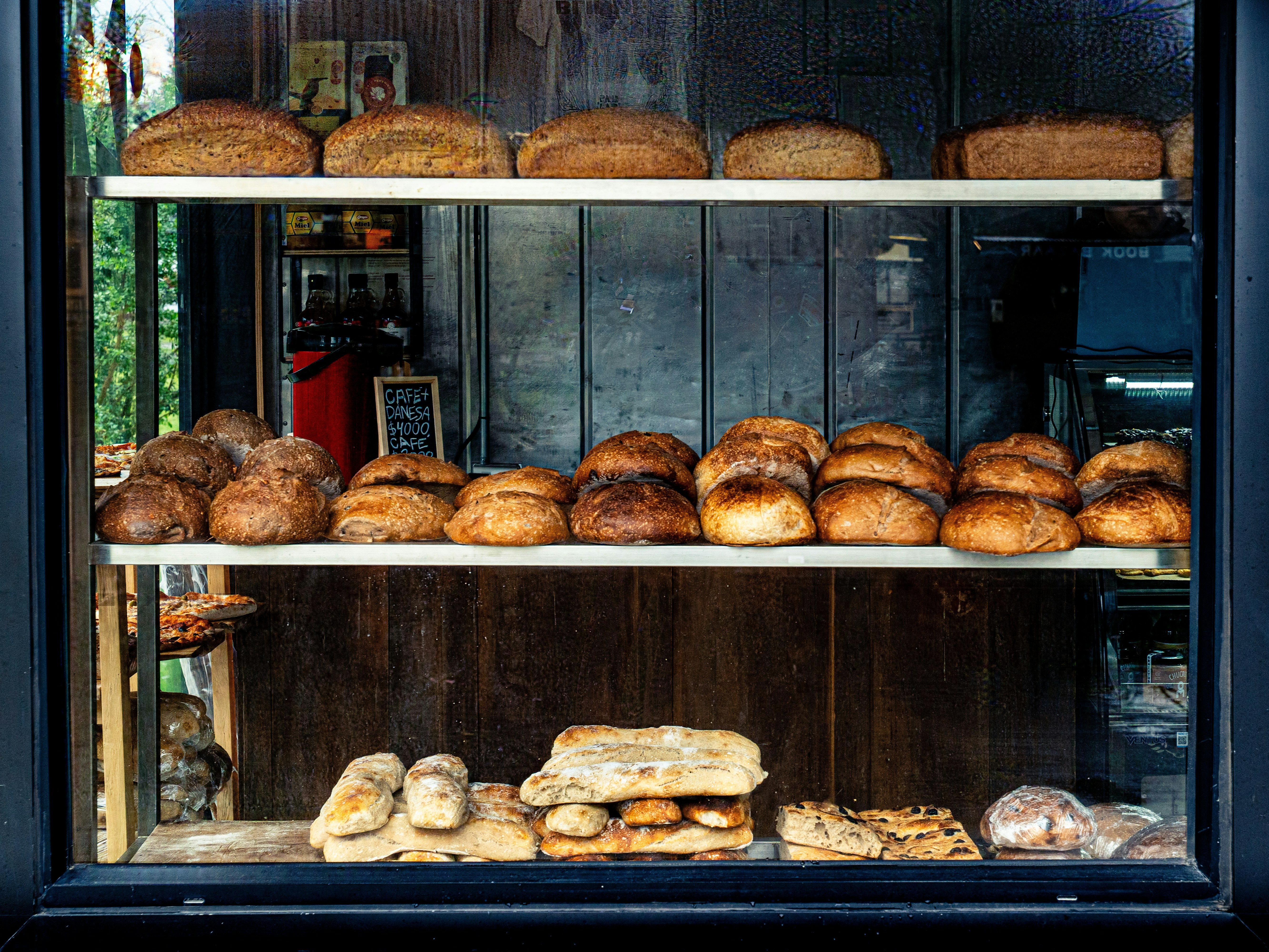 Various loaves of bread displayed on shelves