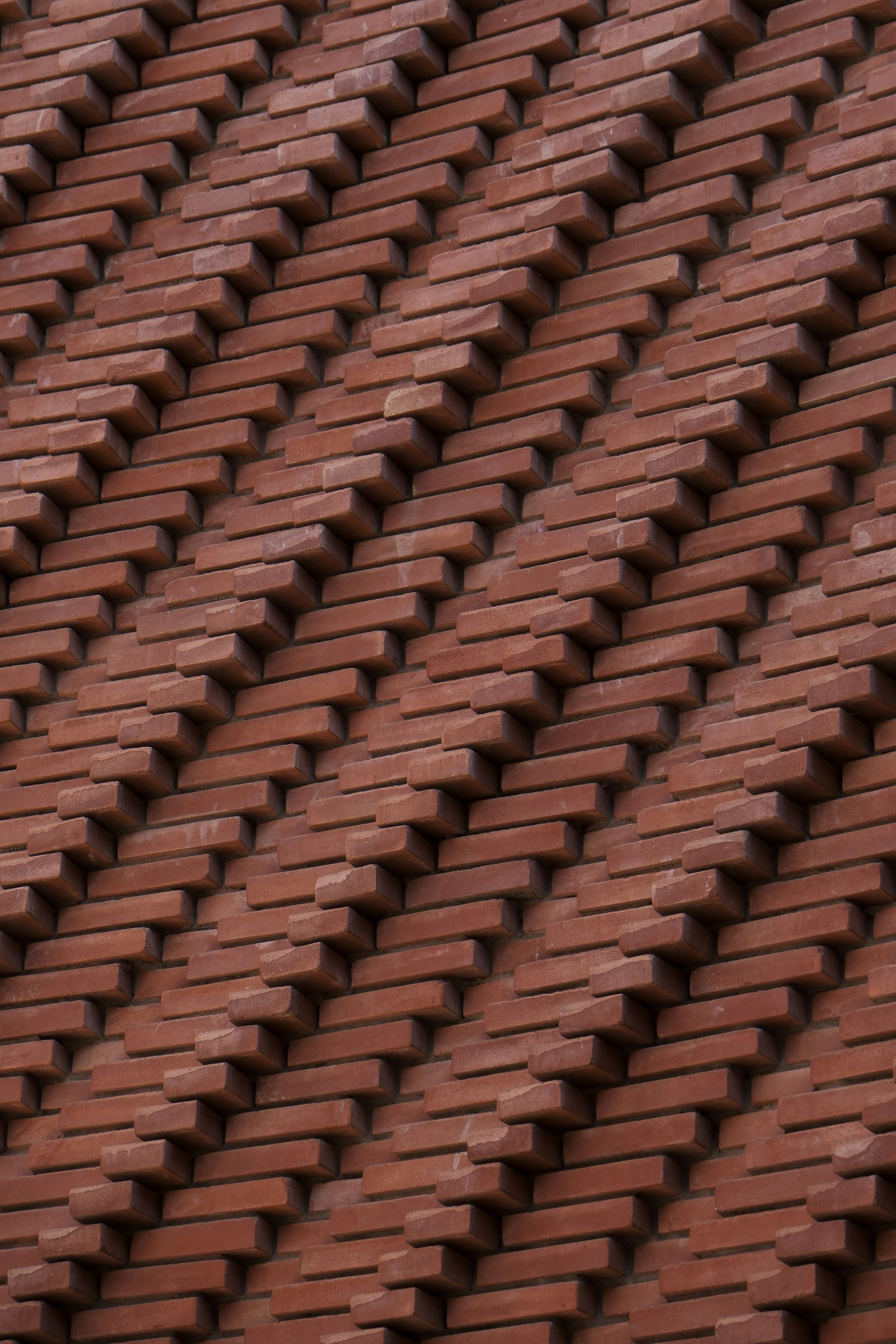 Terracotta Rhythm: A Diagonal Mosaic of Brick Protrusions
