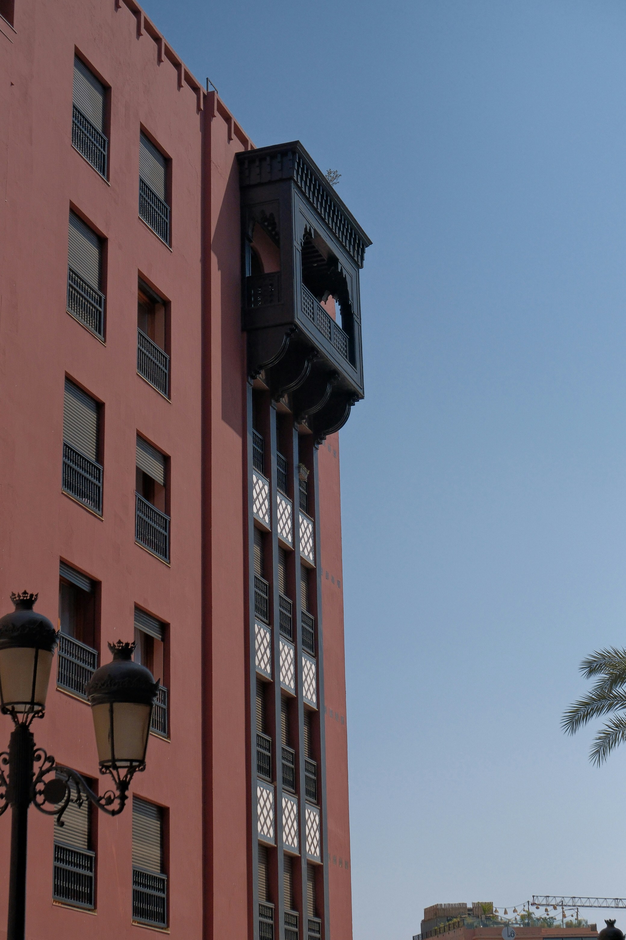 Red building with ornate dark wooden elevator shaft