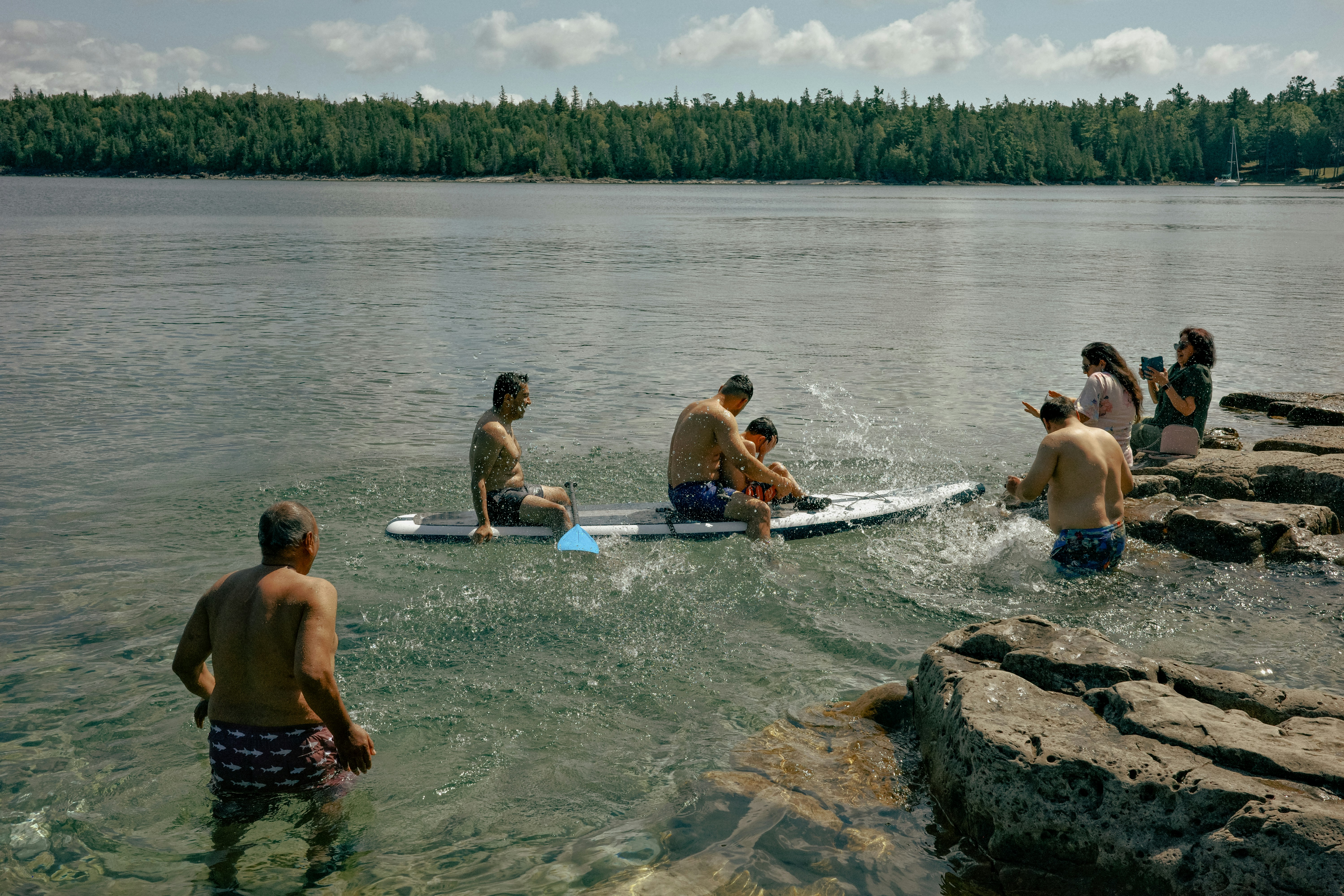 people-paddle-boarding-on-a-clear-lake | People paddle boarding on a clear lake