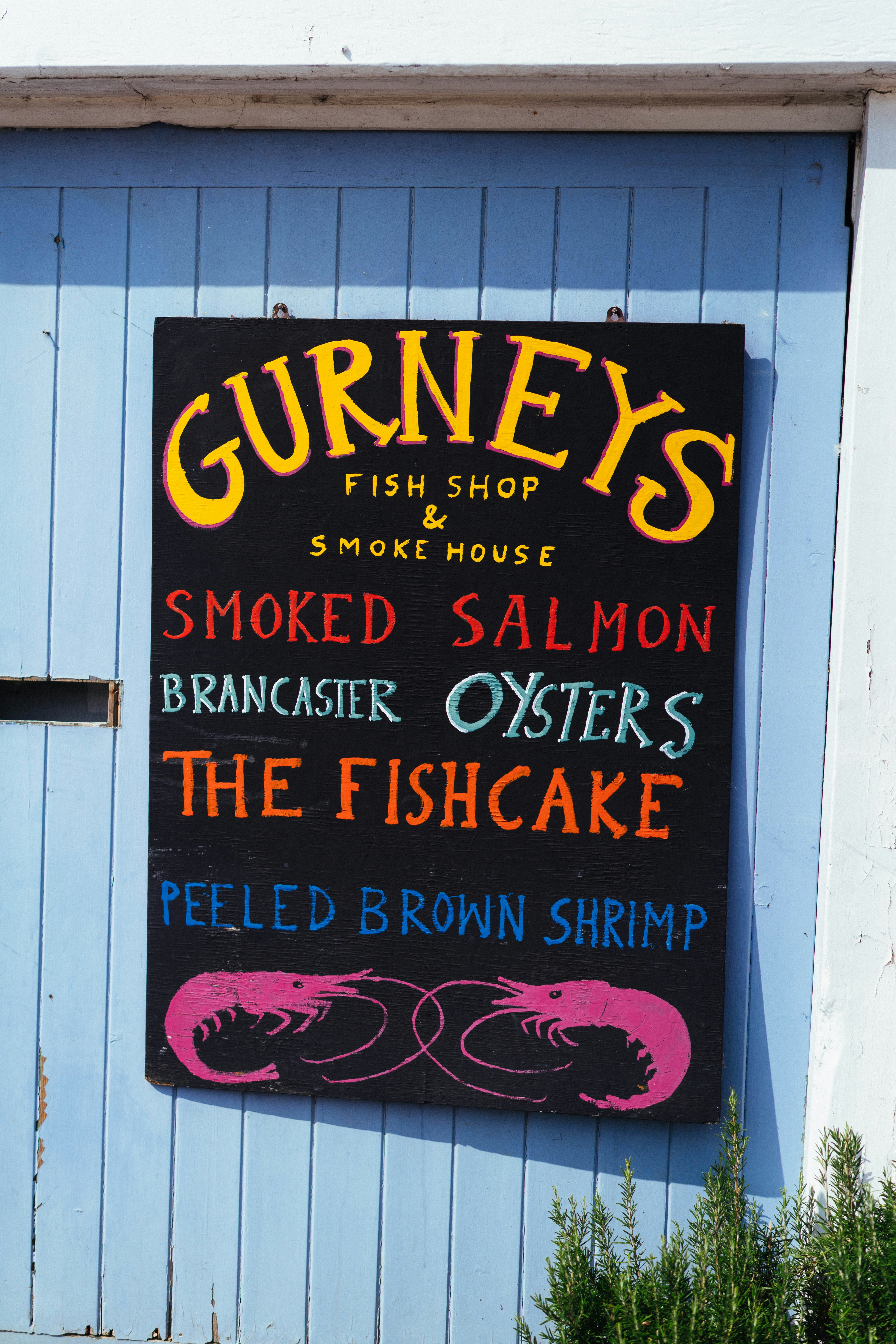 Gurneys fish shop & smokehouse sign photo – Free Image on Unsplash