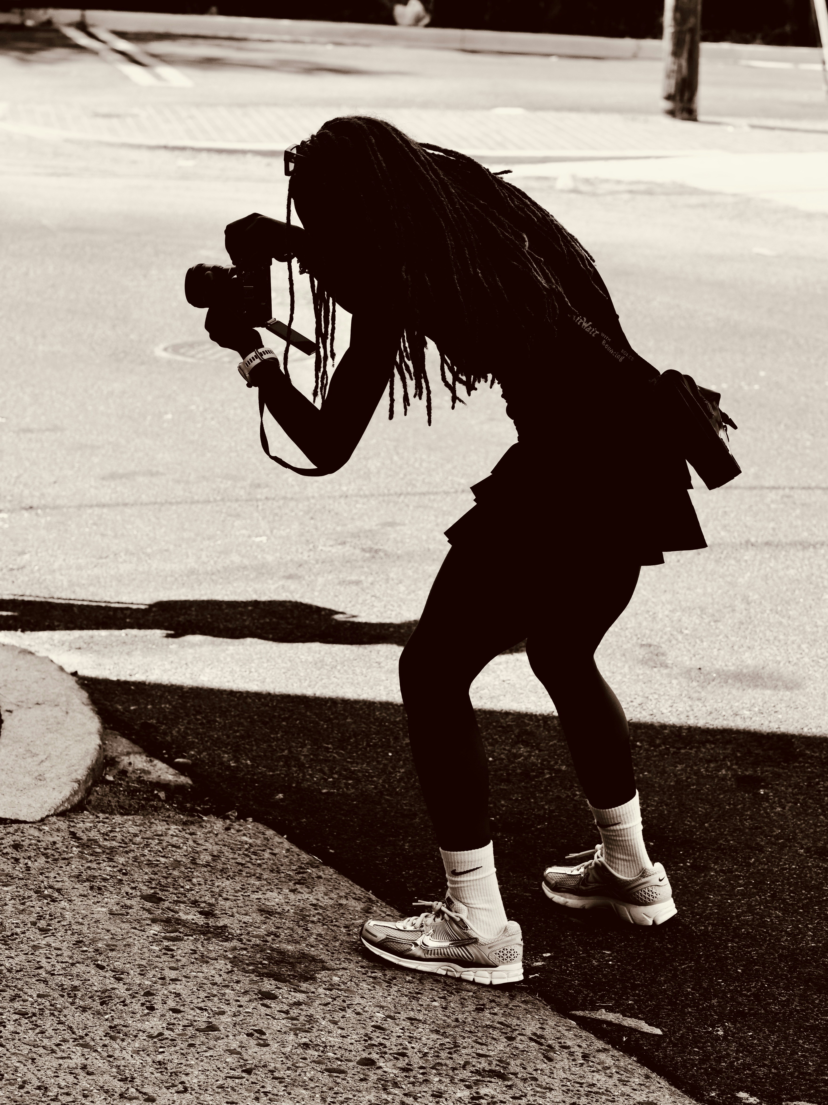 Silhouette of a photographer | Silhouette of a photographer taking a picture outdoors picture