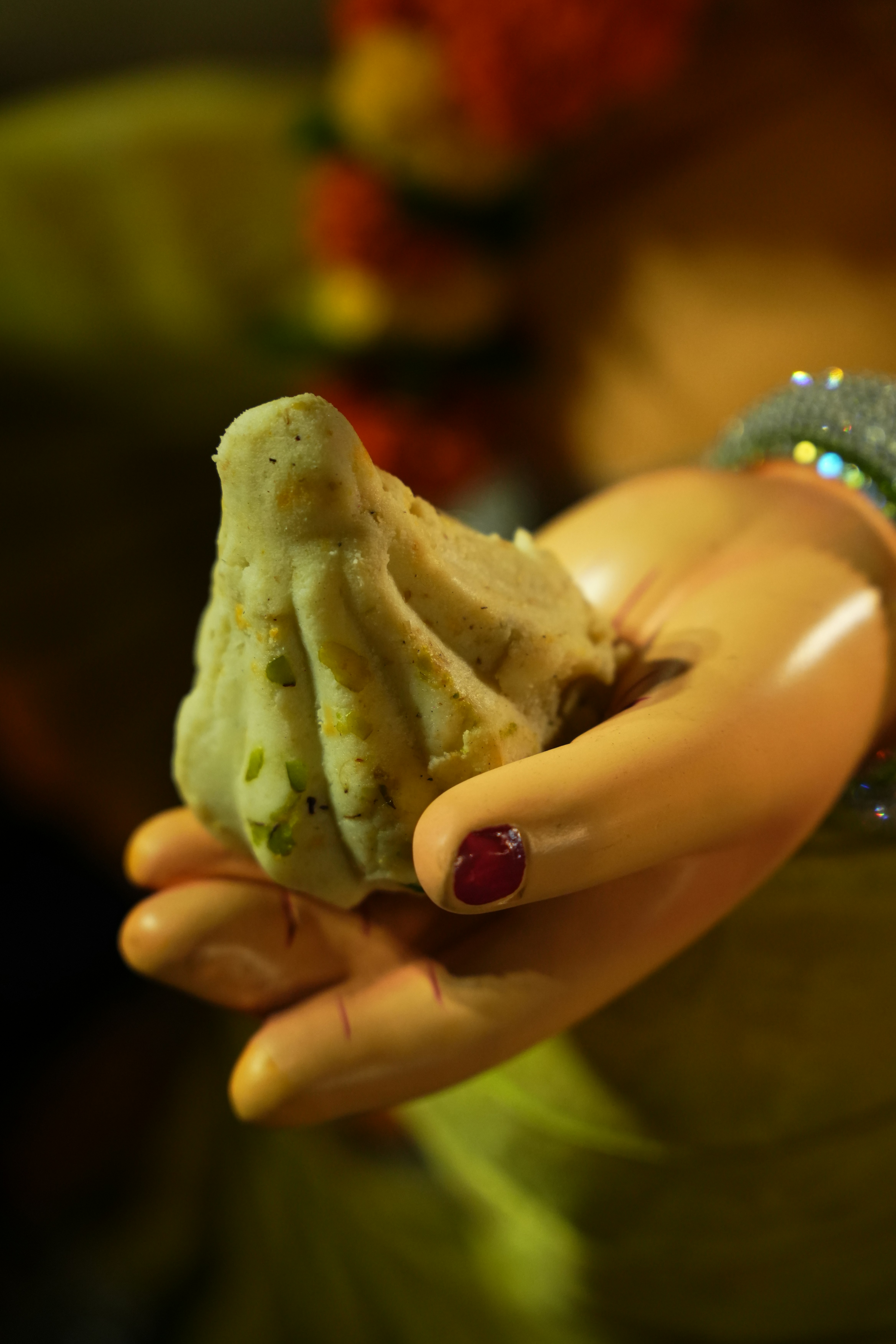 A hand holding a sweet modak dessert. photo – Free Image on Unsplash