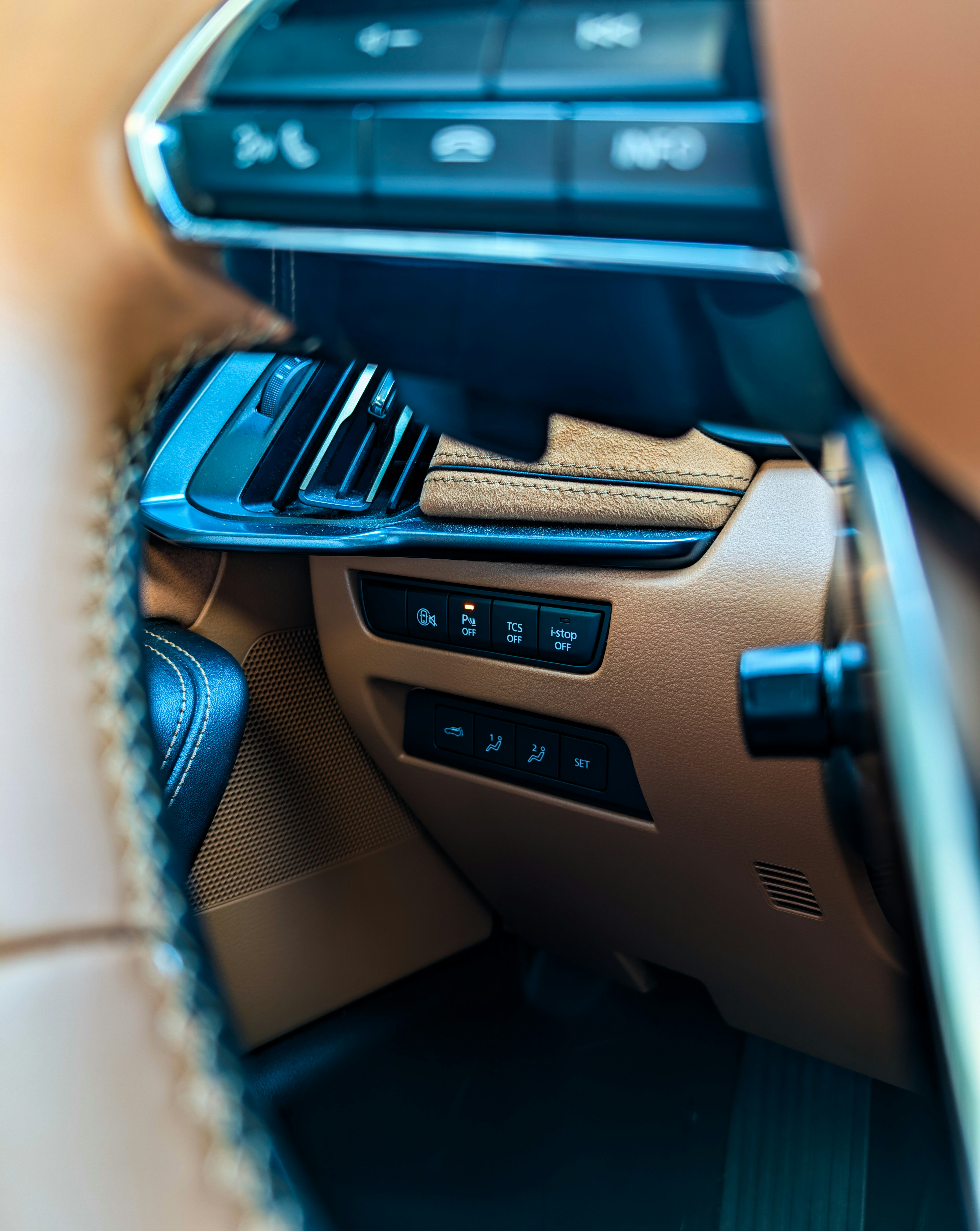The cabin's meticulous design is on full display, showcasing exquisite tan leather, precise stitching, and elegant chrome details. A truly refined and sophisticated interior experience for any discerning driver.