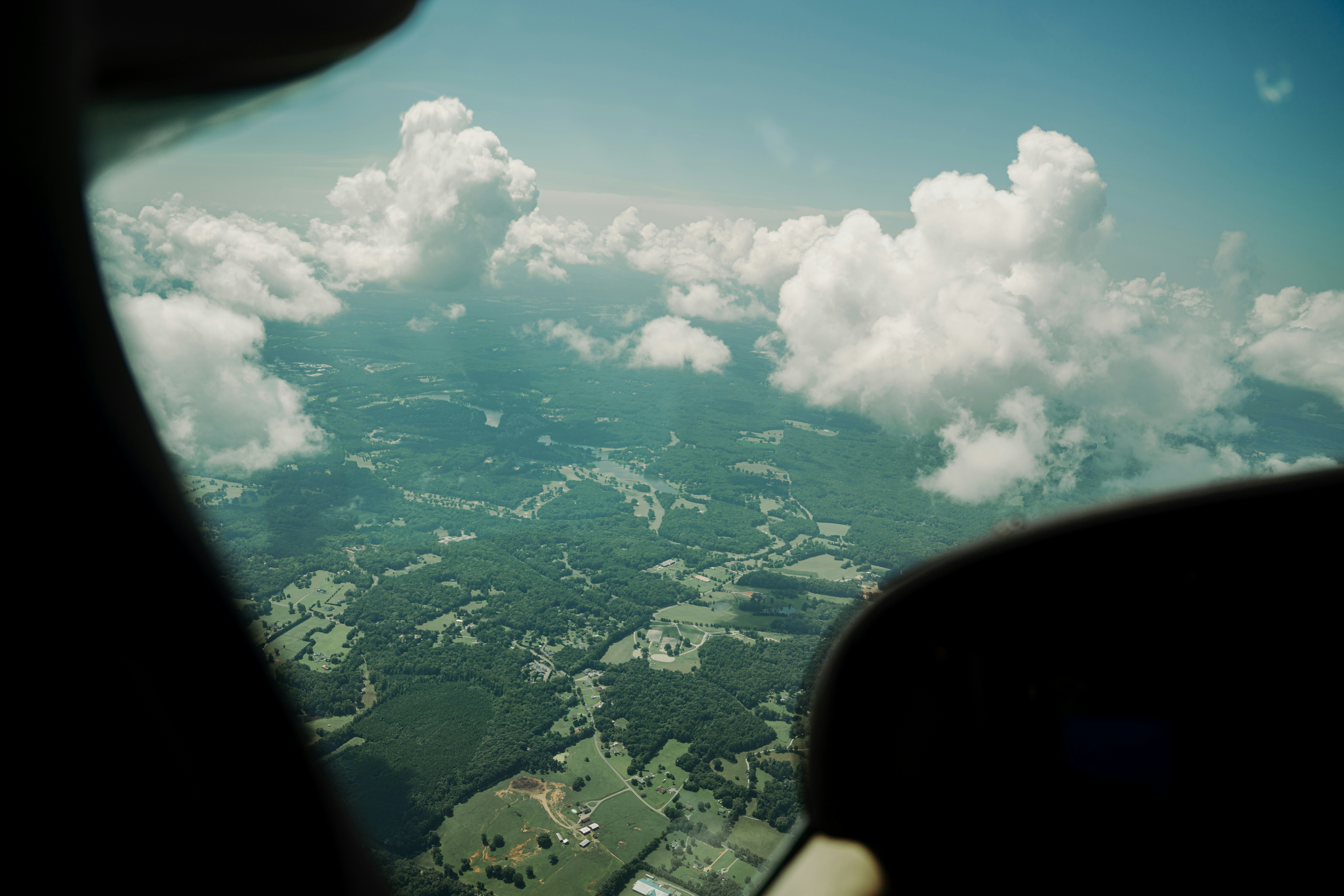 Aerial Mosaic: Nature's Patchwork Beneath the Clouds
