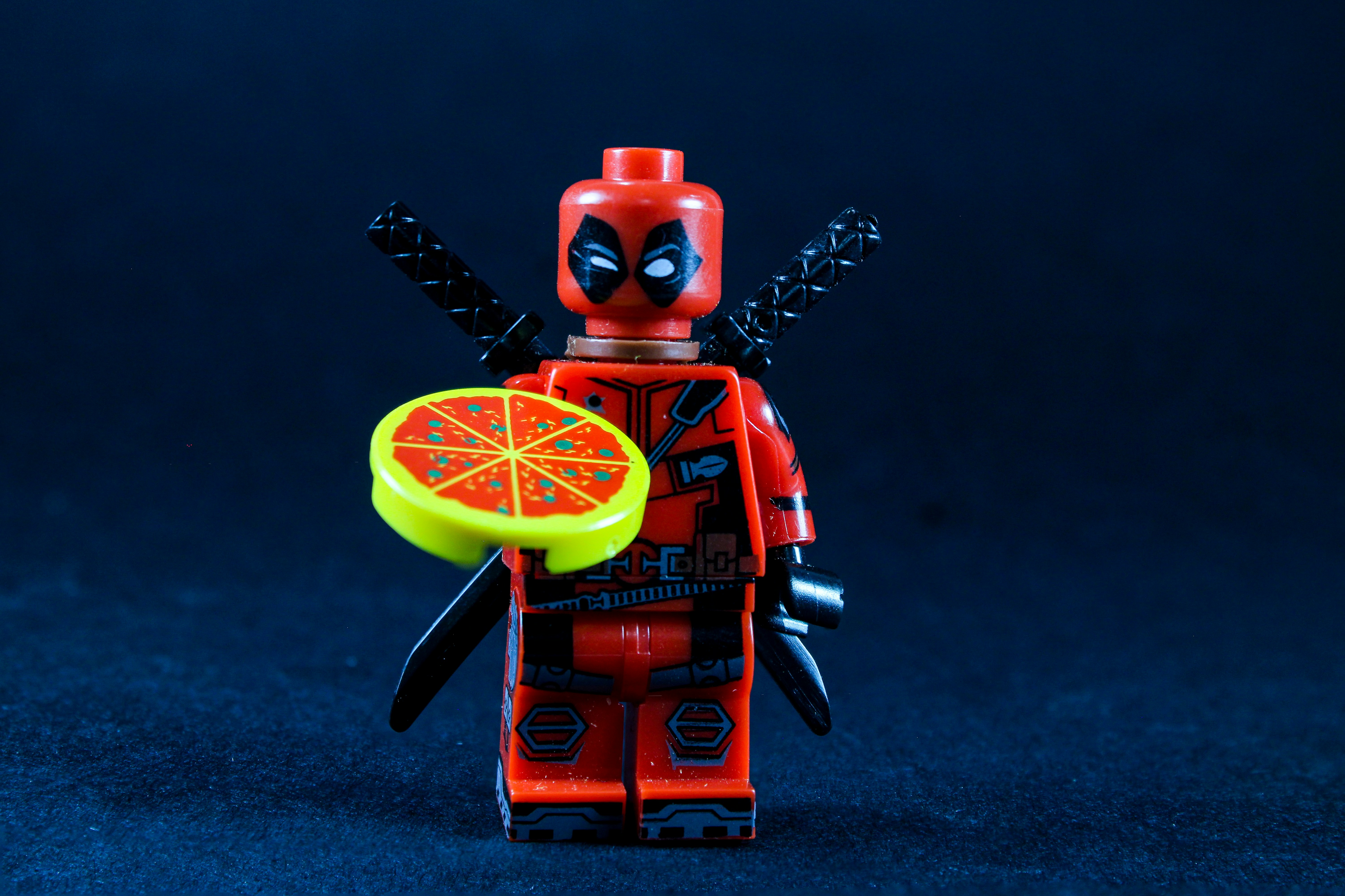 Lego Deadpool Enjoying his Pizza. | Lego deadpool holding a slice of pizza