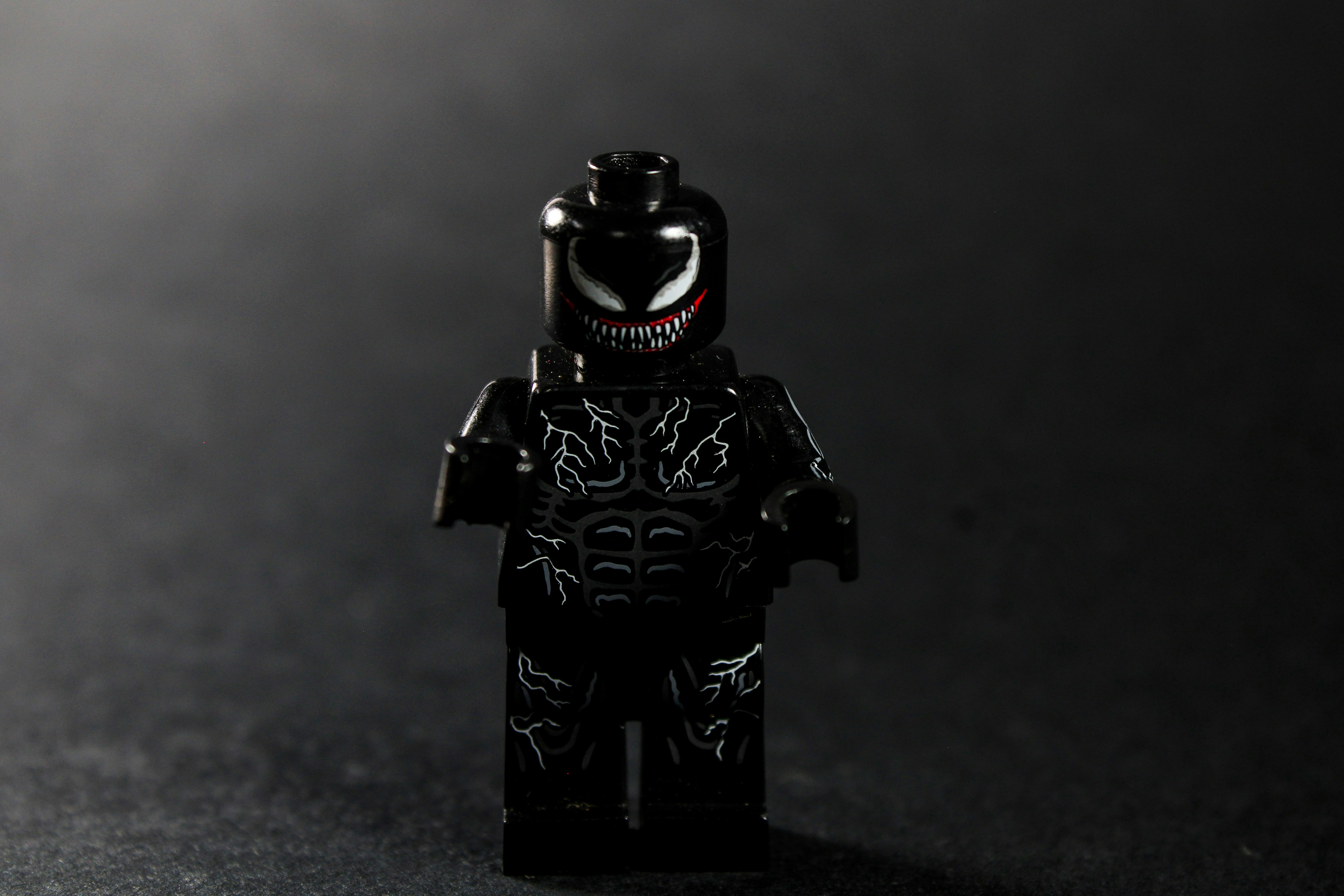 Midnight Venom: A LEGO minifigure forged in glossy black under studio light