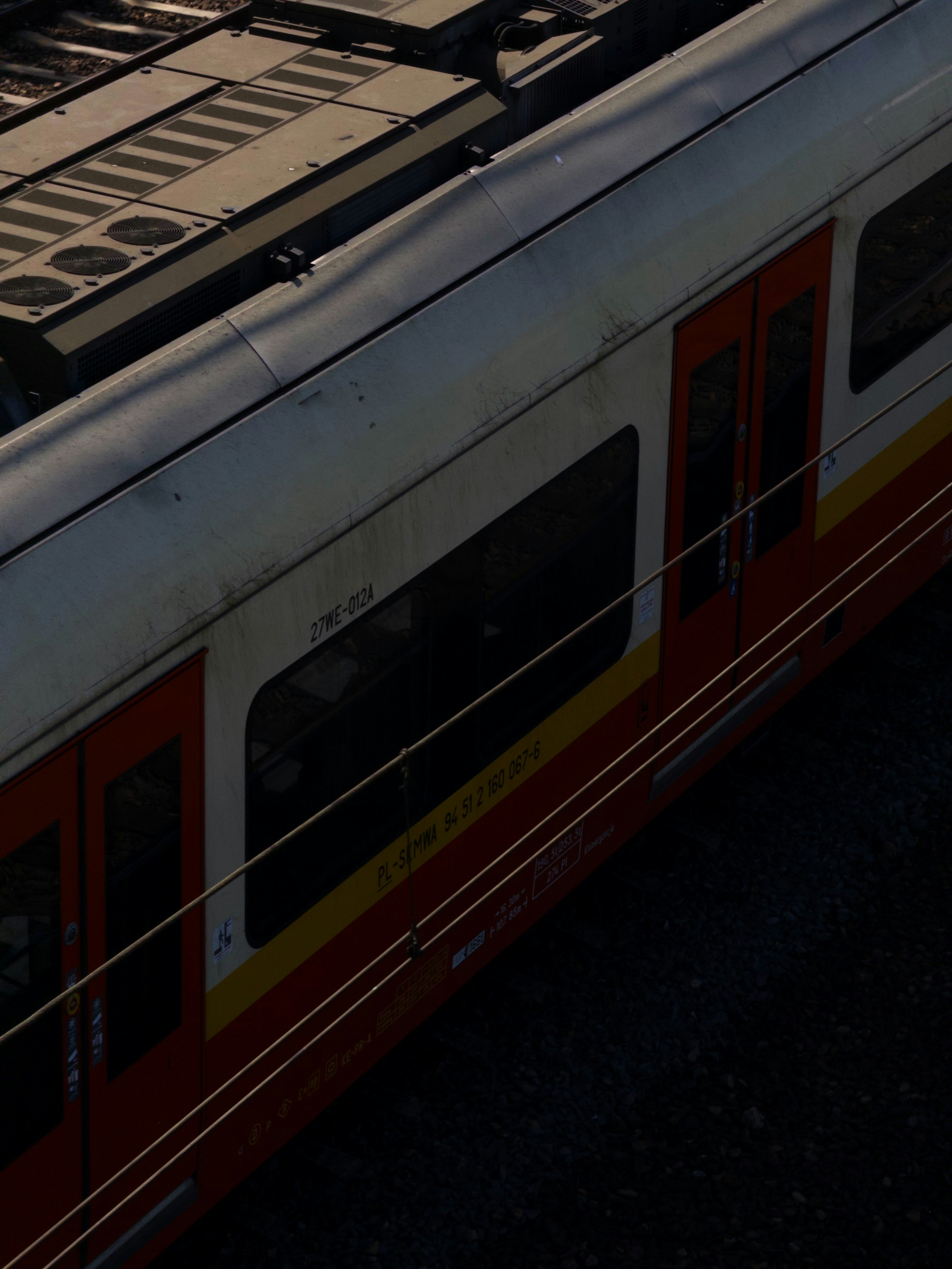A red and white train with yellow accents.