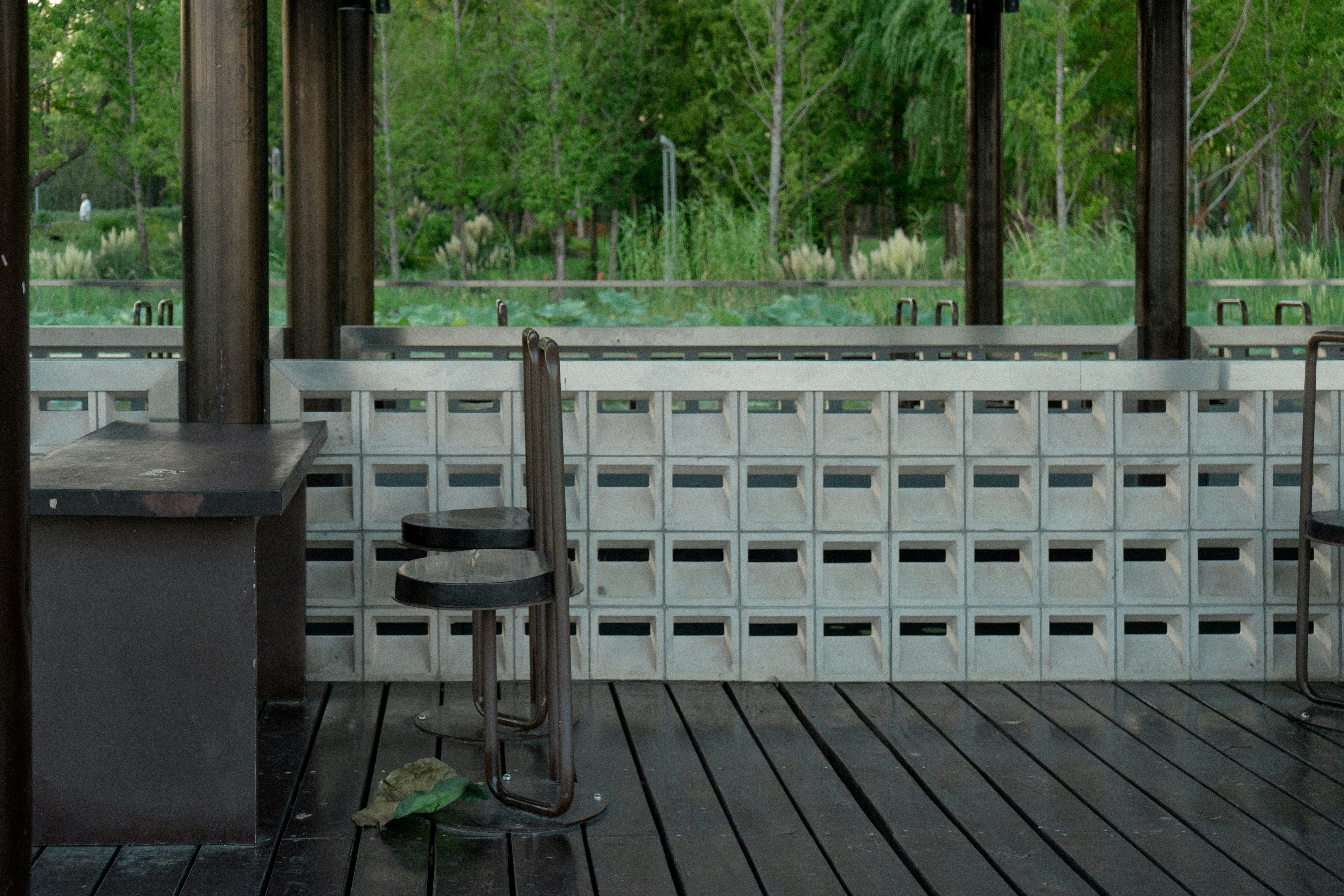 Solitary Chair Beneath a Wooden Pavilion on a Weathered Deck