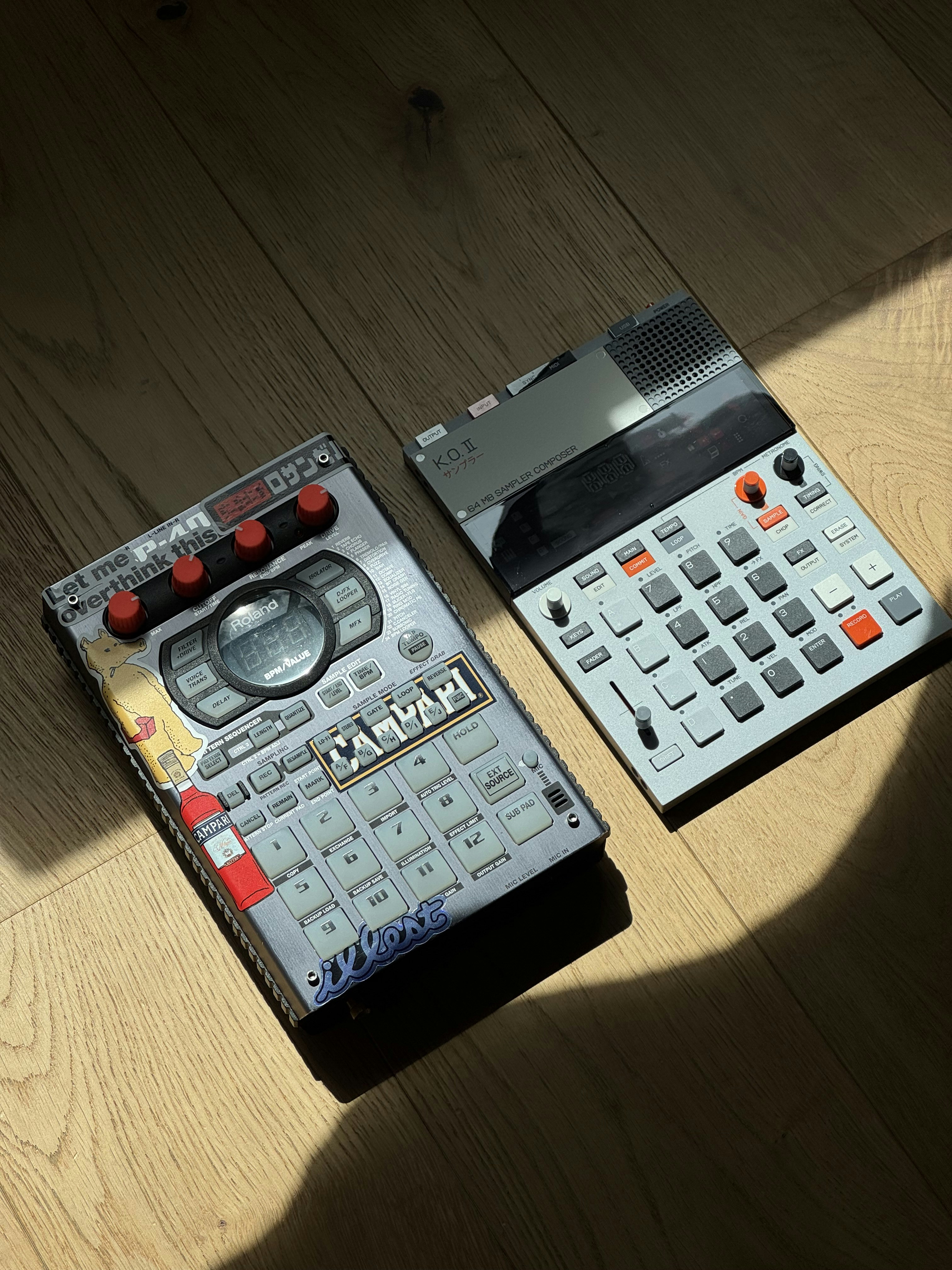 Download my presets: https://bodega.supply/collection/photo-presets 👈 | Two electronic music production devices on wooden floor.