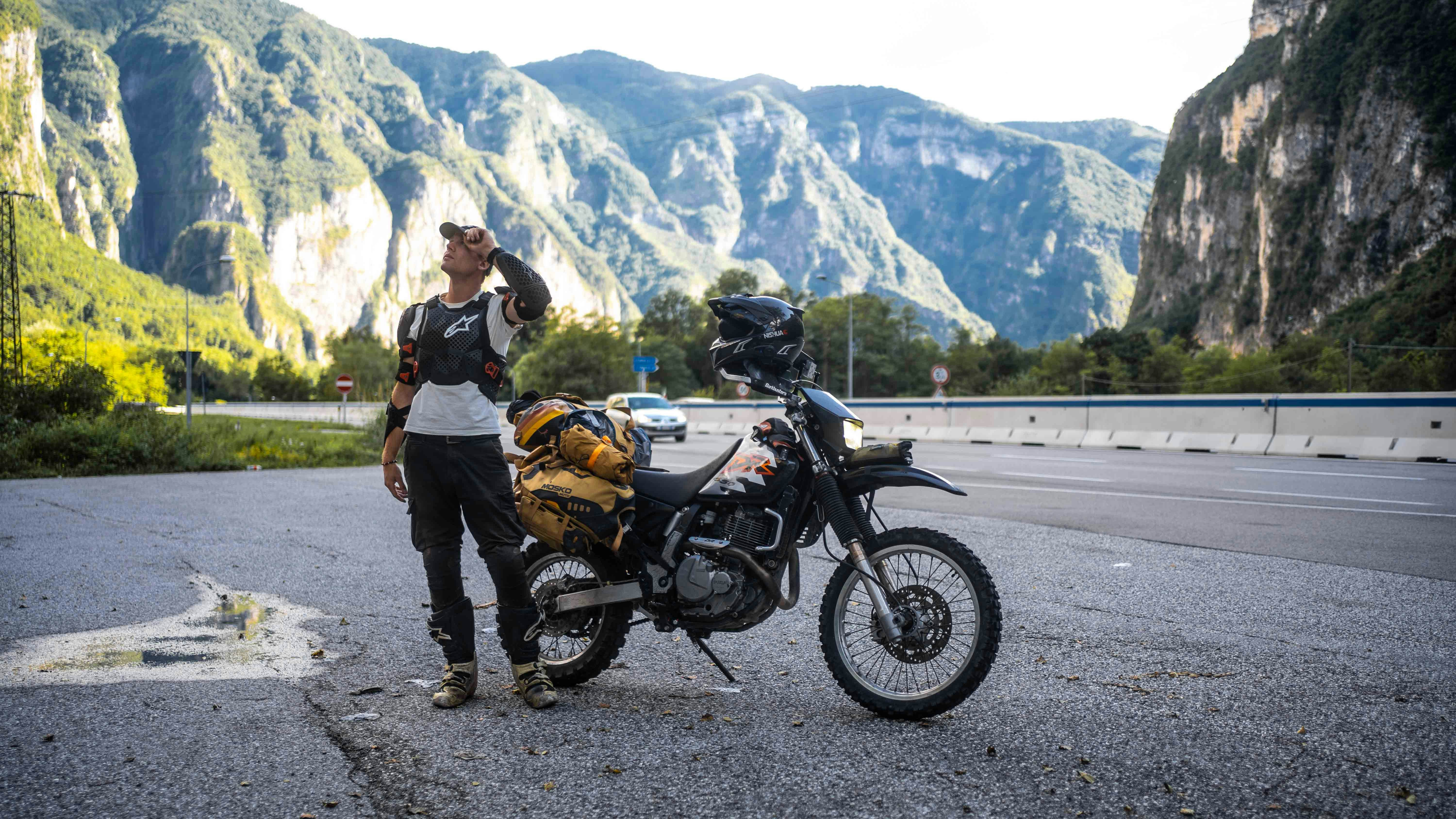 Journey's Pause: A Rider's Reflection Amidst Majestic Peaks