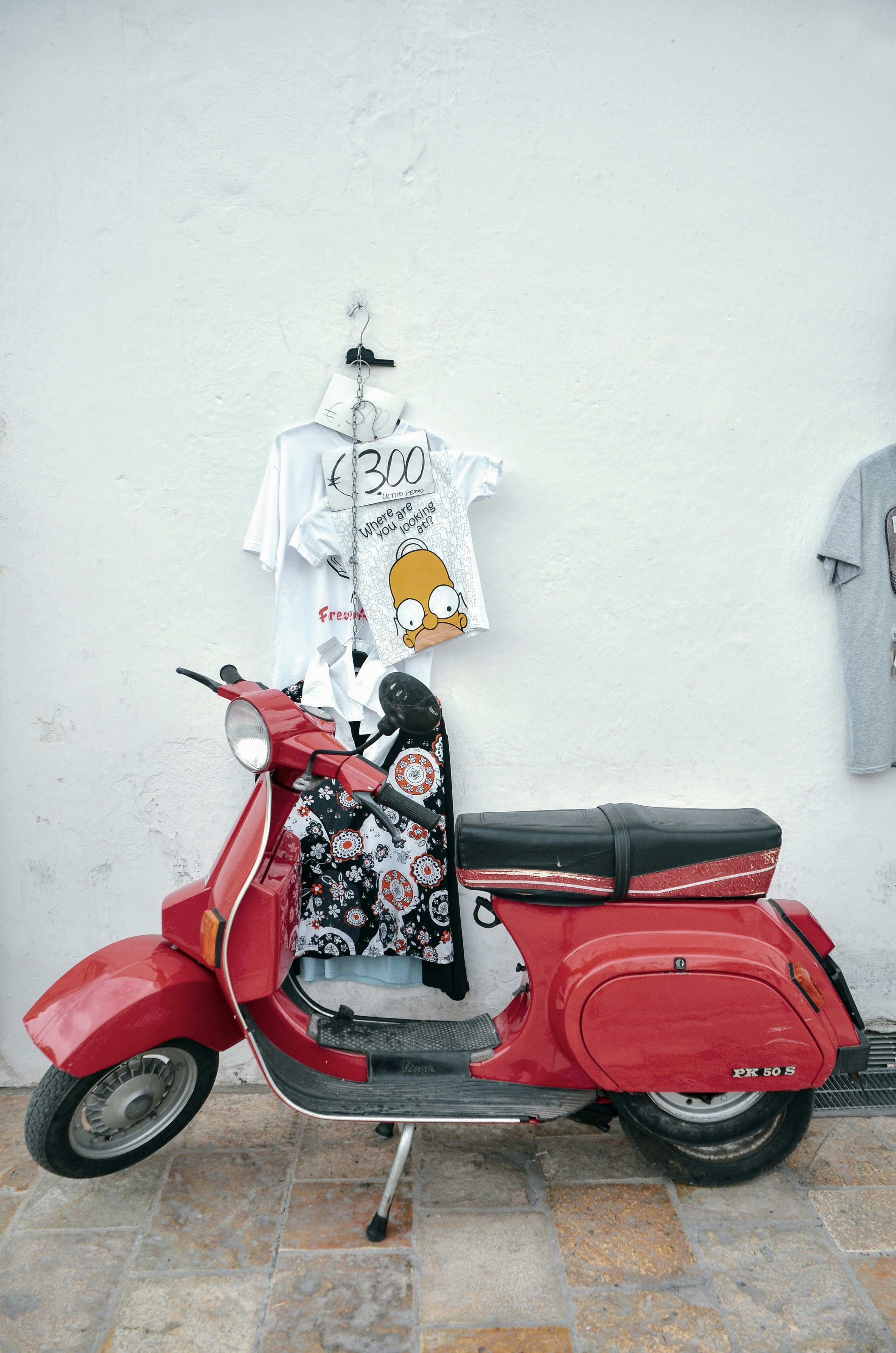 Vintage Charm: A Red Scooter's Urban Elegance