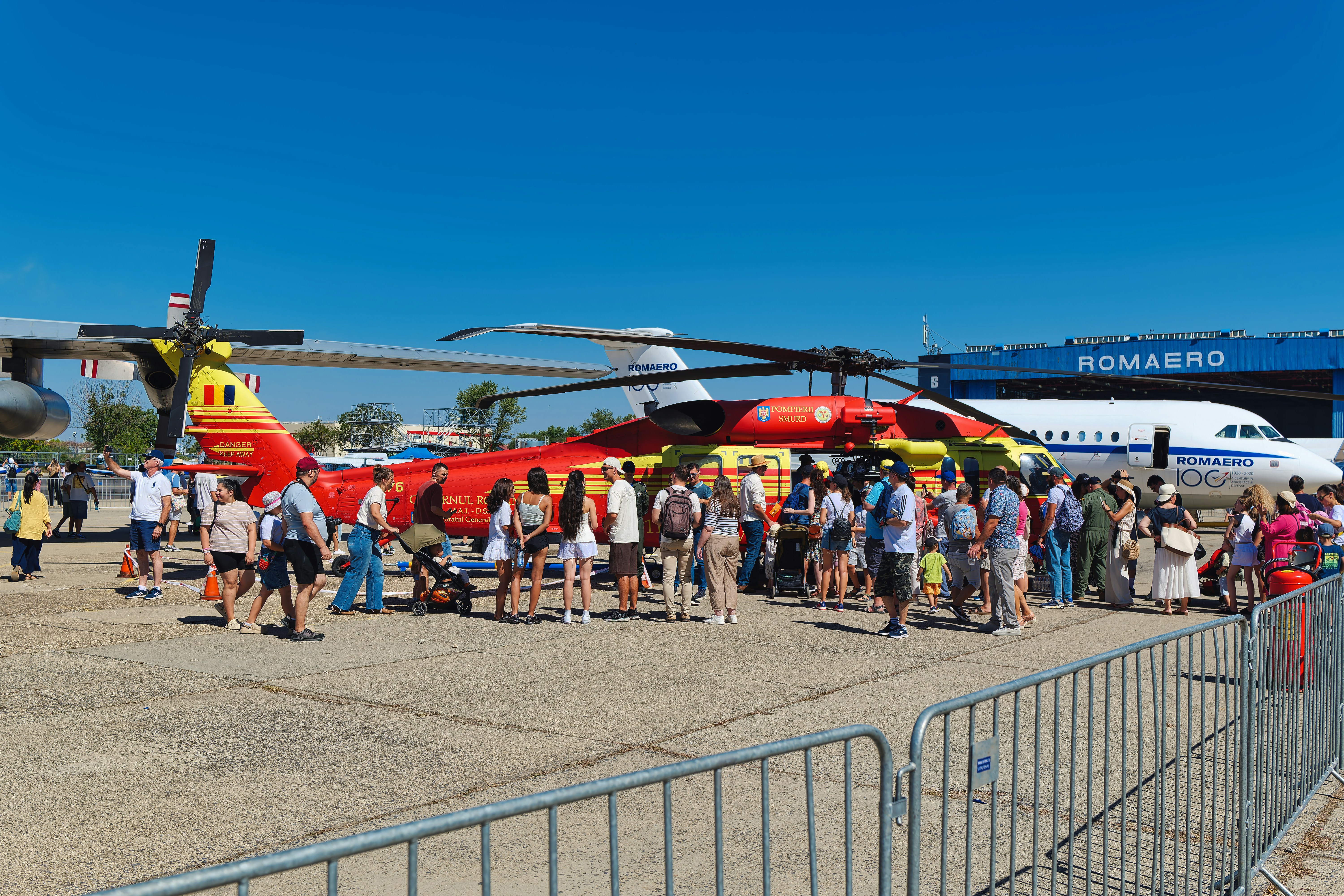Sunlit Rendezvous Around a Red-Yellow Rescue Helicopter at an Airshow