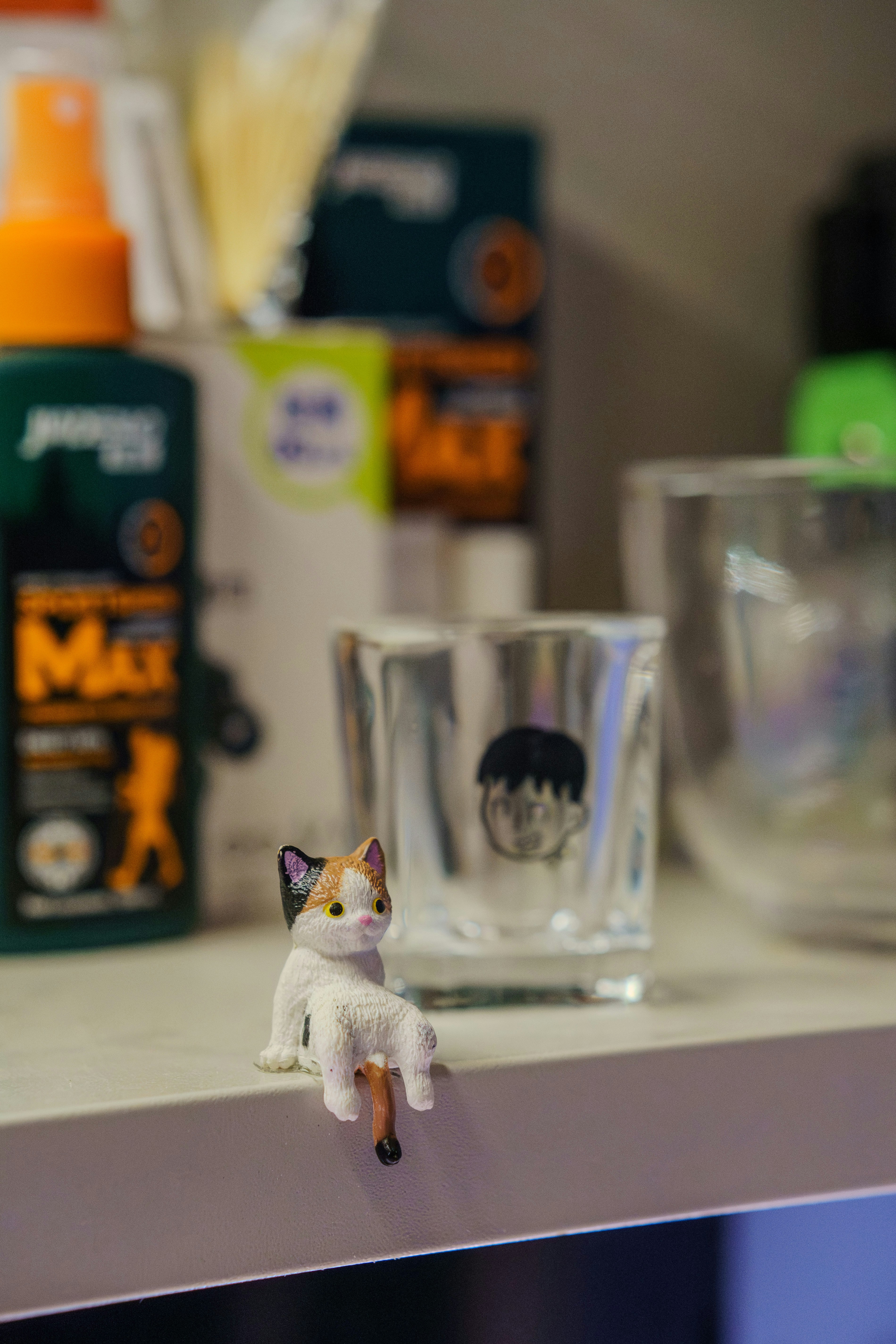 Whimsical Cat Figurine Amidst Everyday Objects