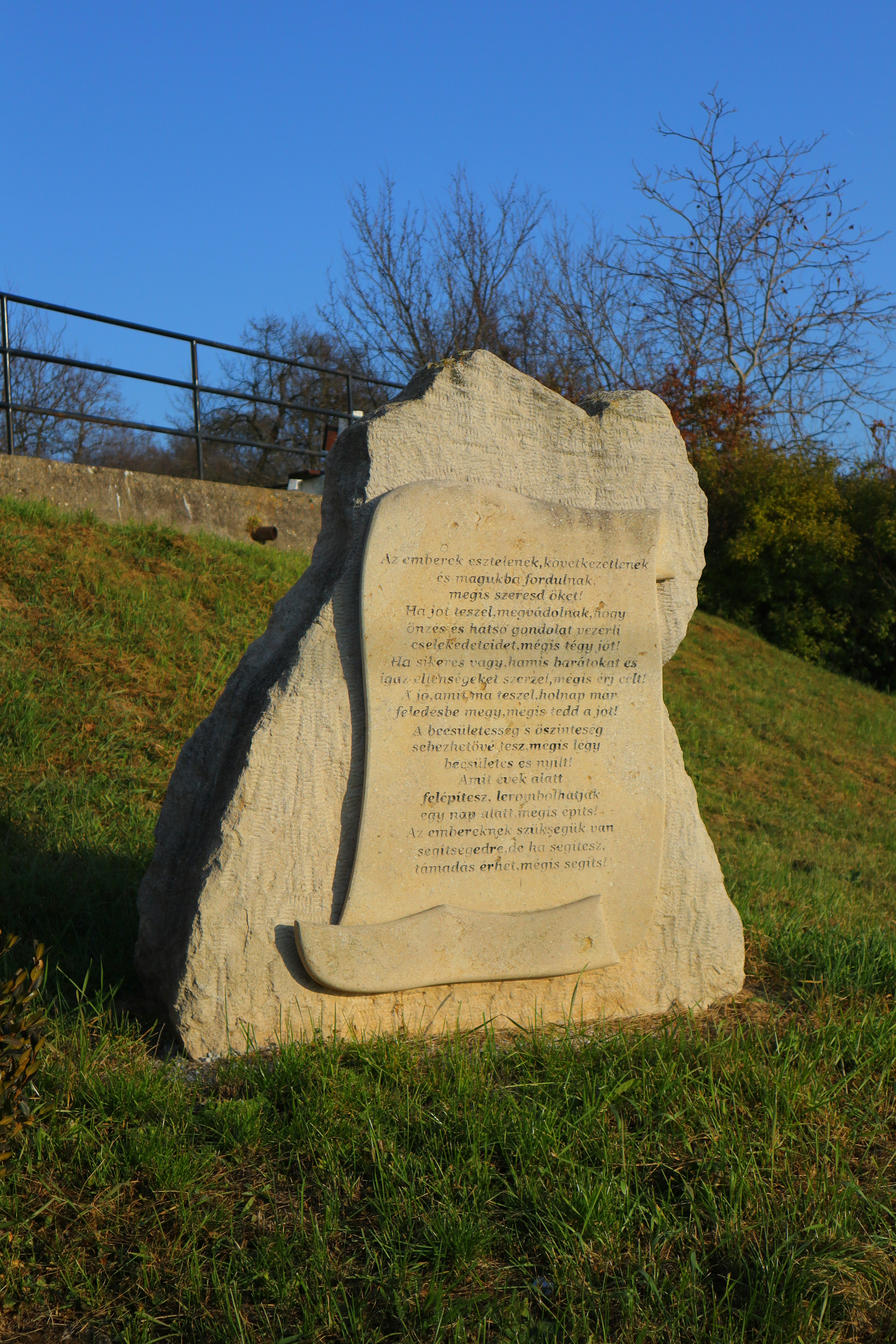 Stone monument with inscribed text on grassy hill photo – Free Village ...