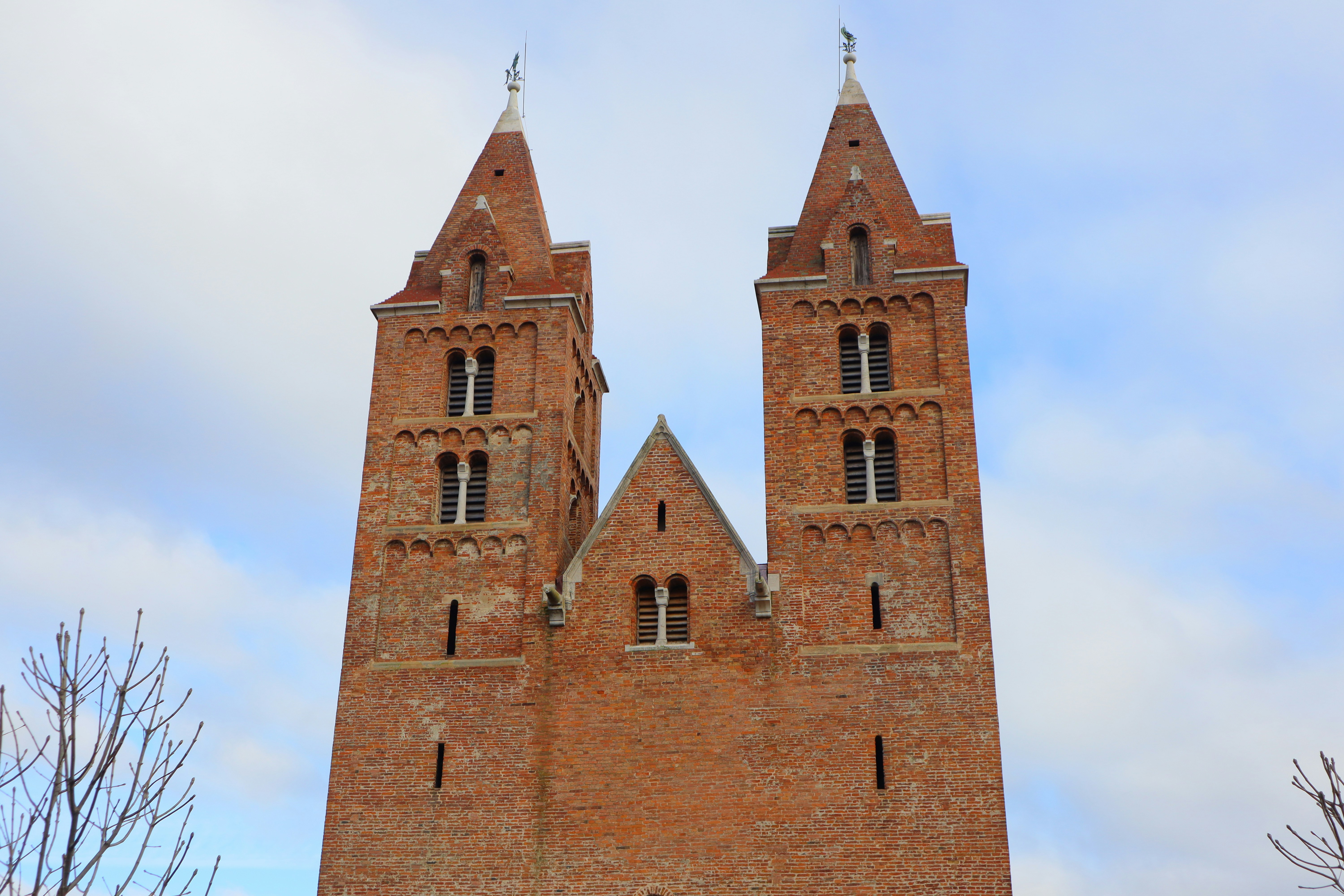 Acâș 2024, Romania | Two brick towers with pointed roofs against sky