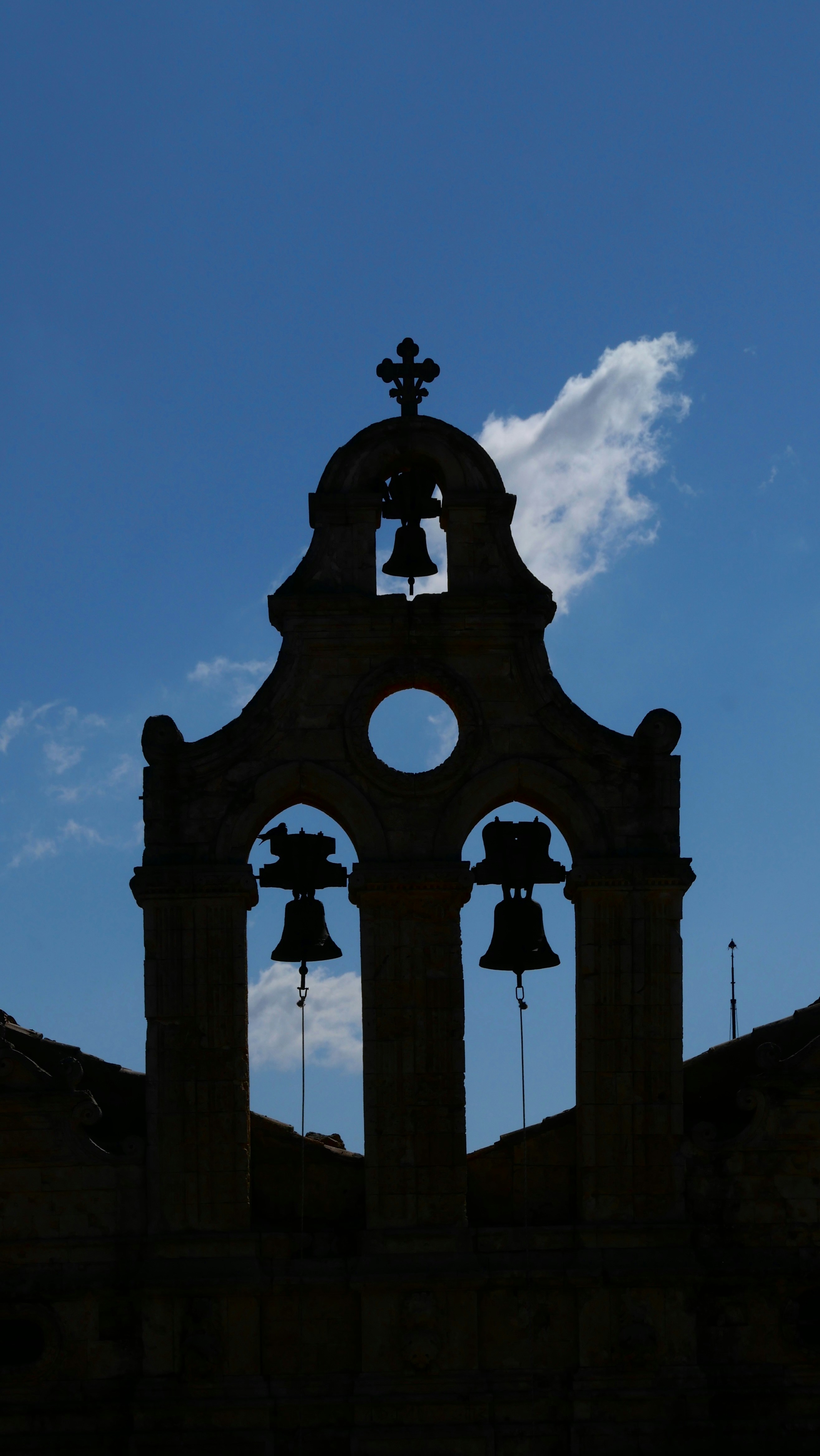 Monastry of Arkadi, Crete | Silhouette of a bell tower against a blue sky.