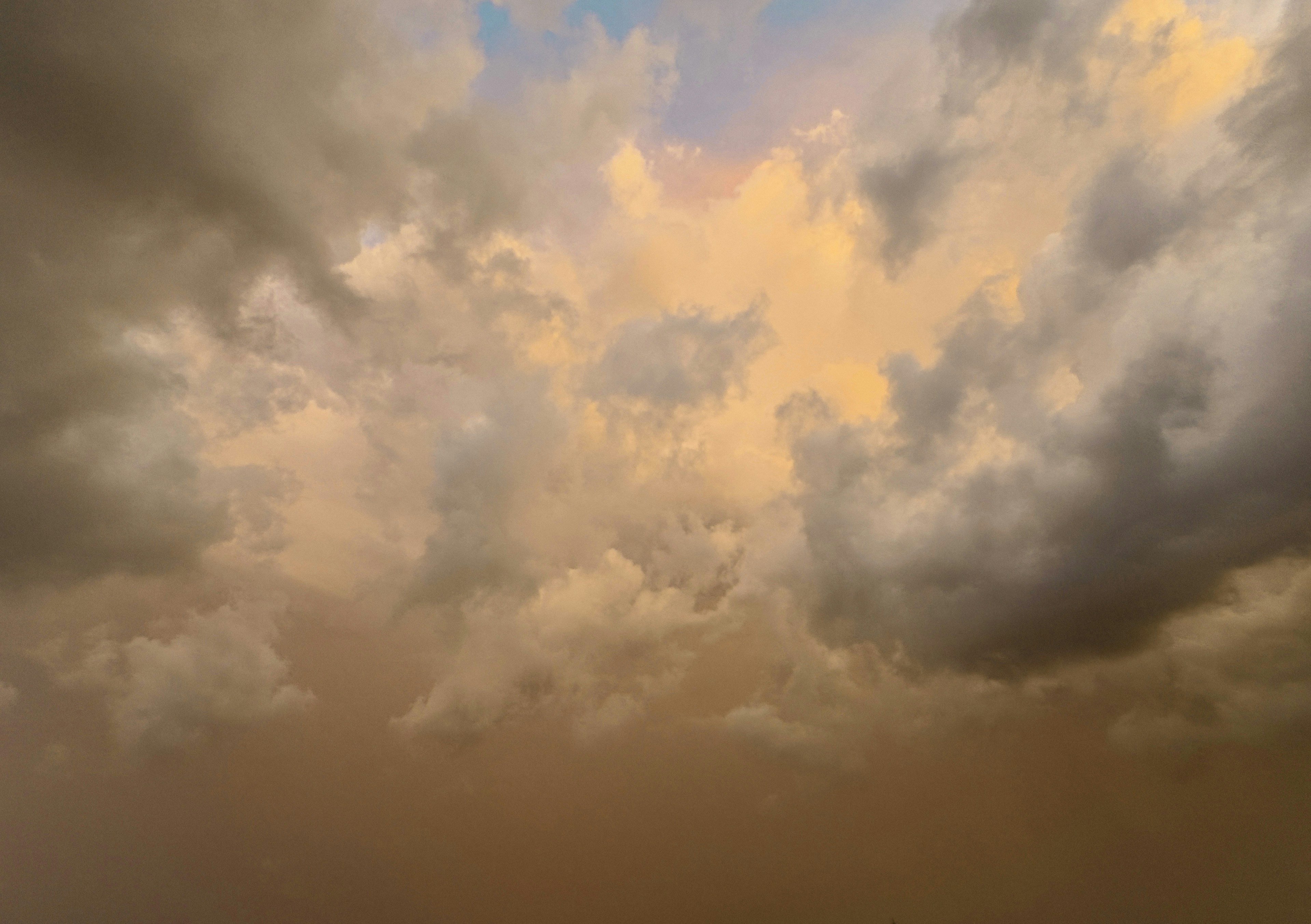 Dramatic storm clouds gather at sunset