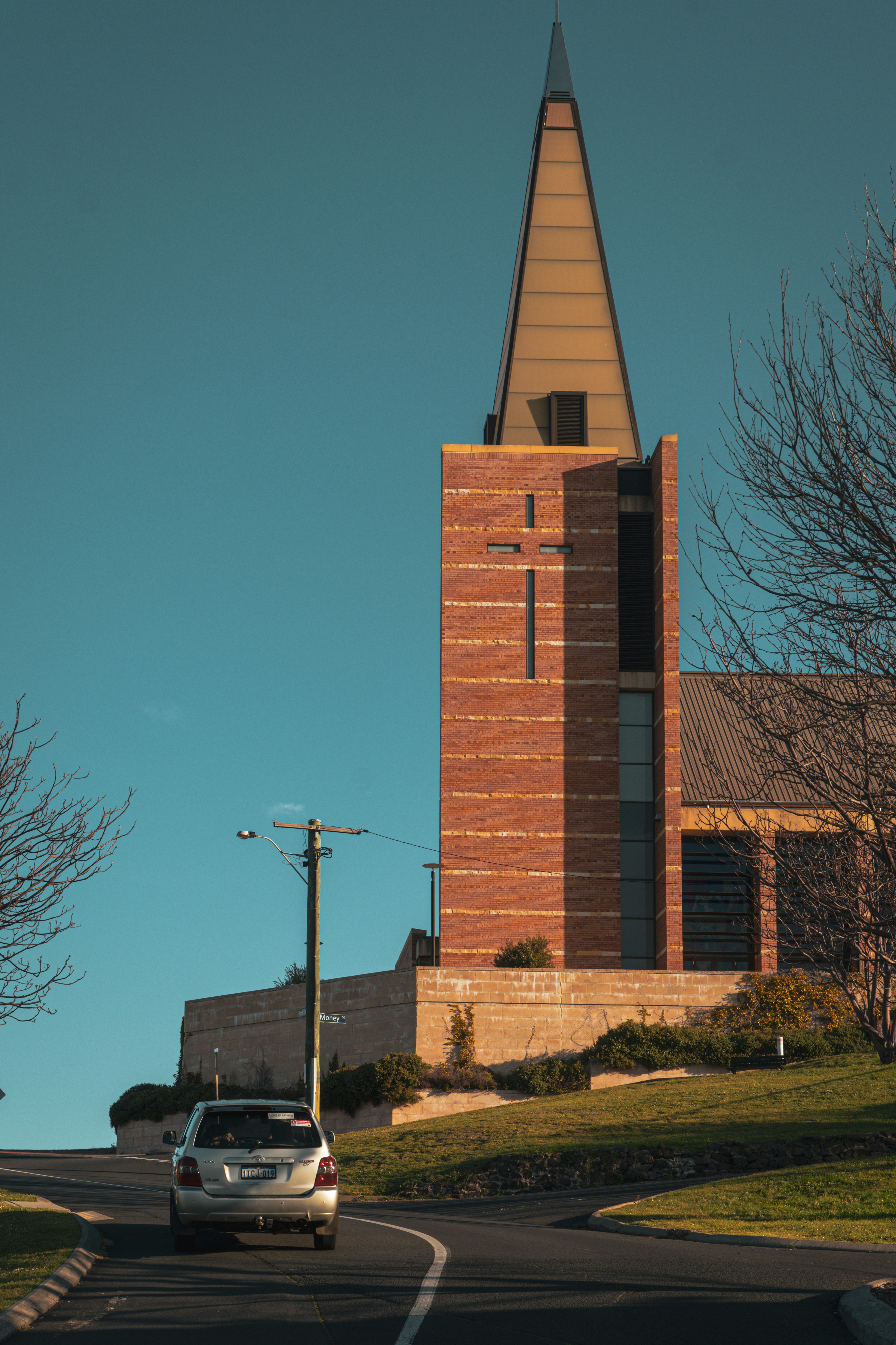 Brick Church Spire Reaching Toward a Clear Sky