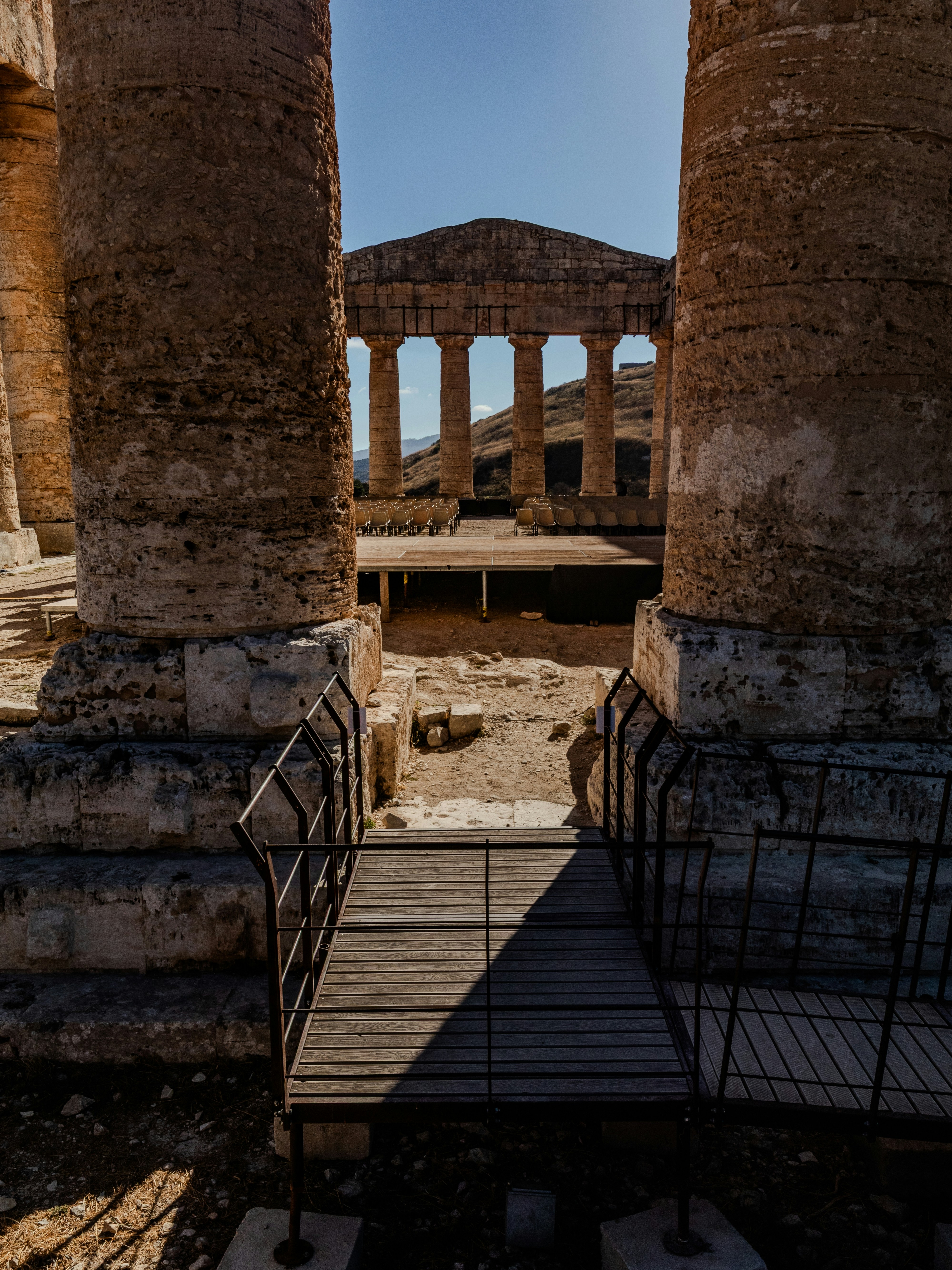 Ancient greek temple ruins with columns and walkway