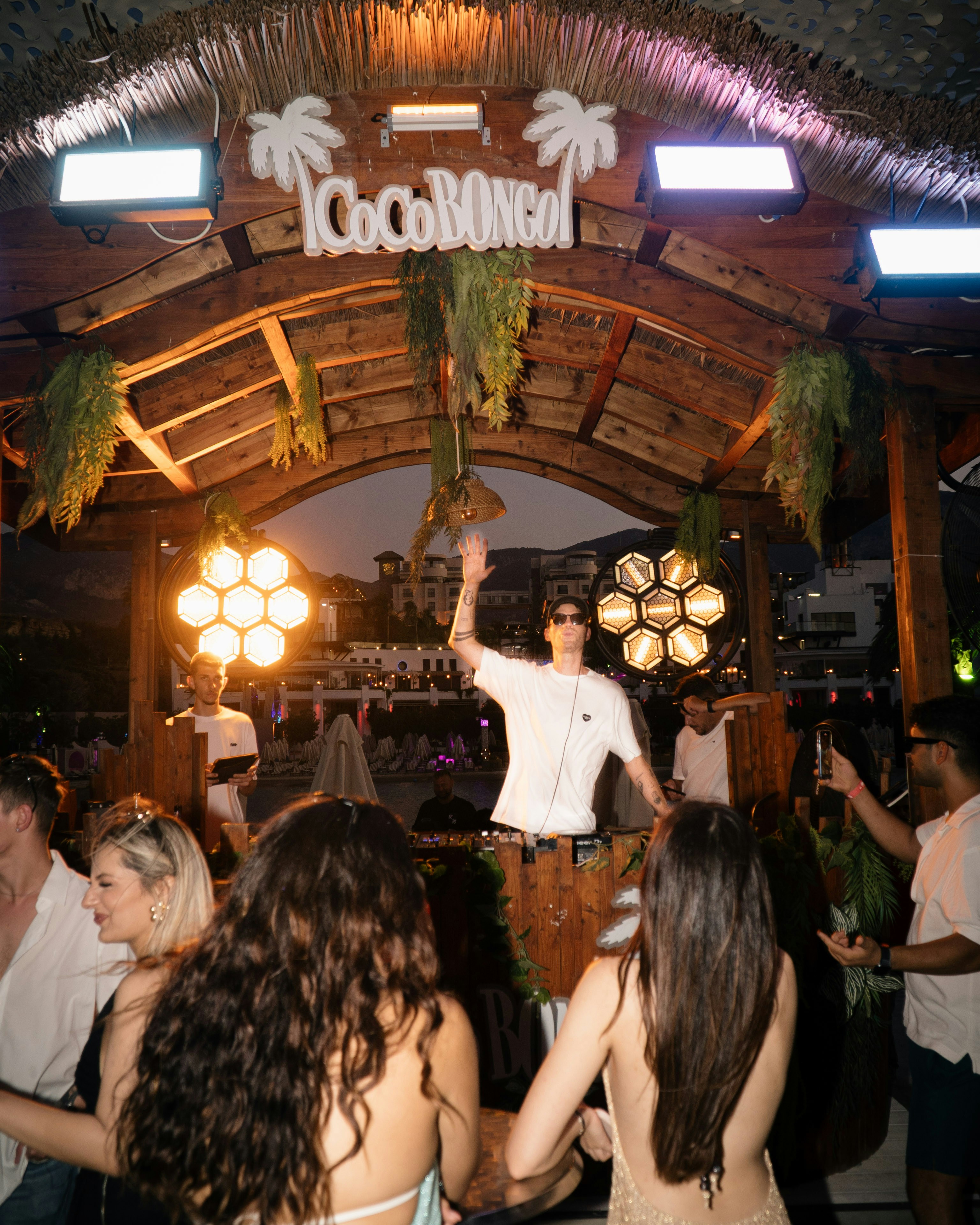 DJ on Stage Under Neon Canopy at Coco Bongol Bamboo Lounge