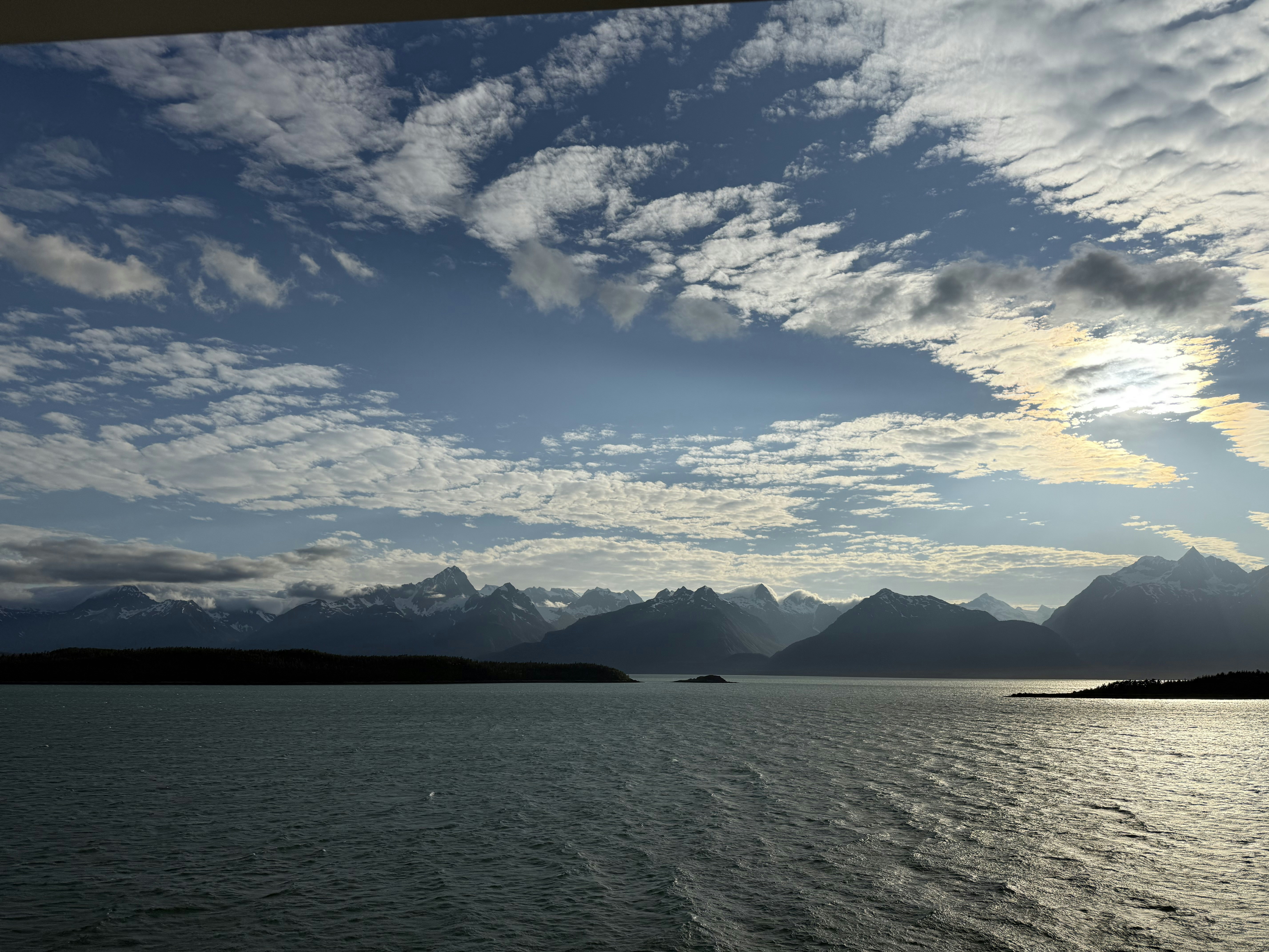 Majestic mountains rise above a calm sea under clouds. photo – Free ...