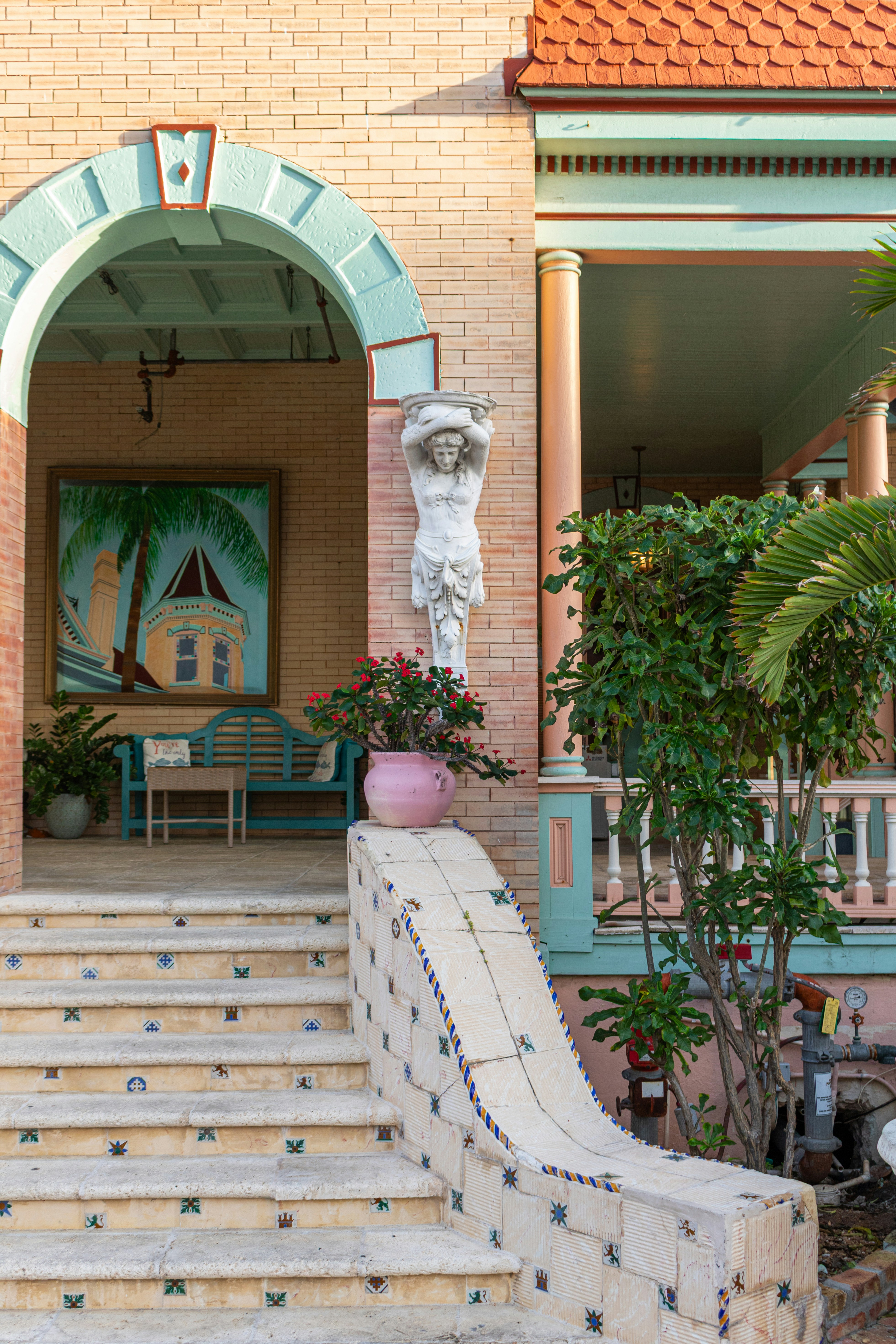 Pastel Veranda Guardian: Statue Between Arch and Garden