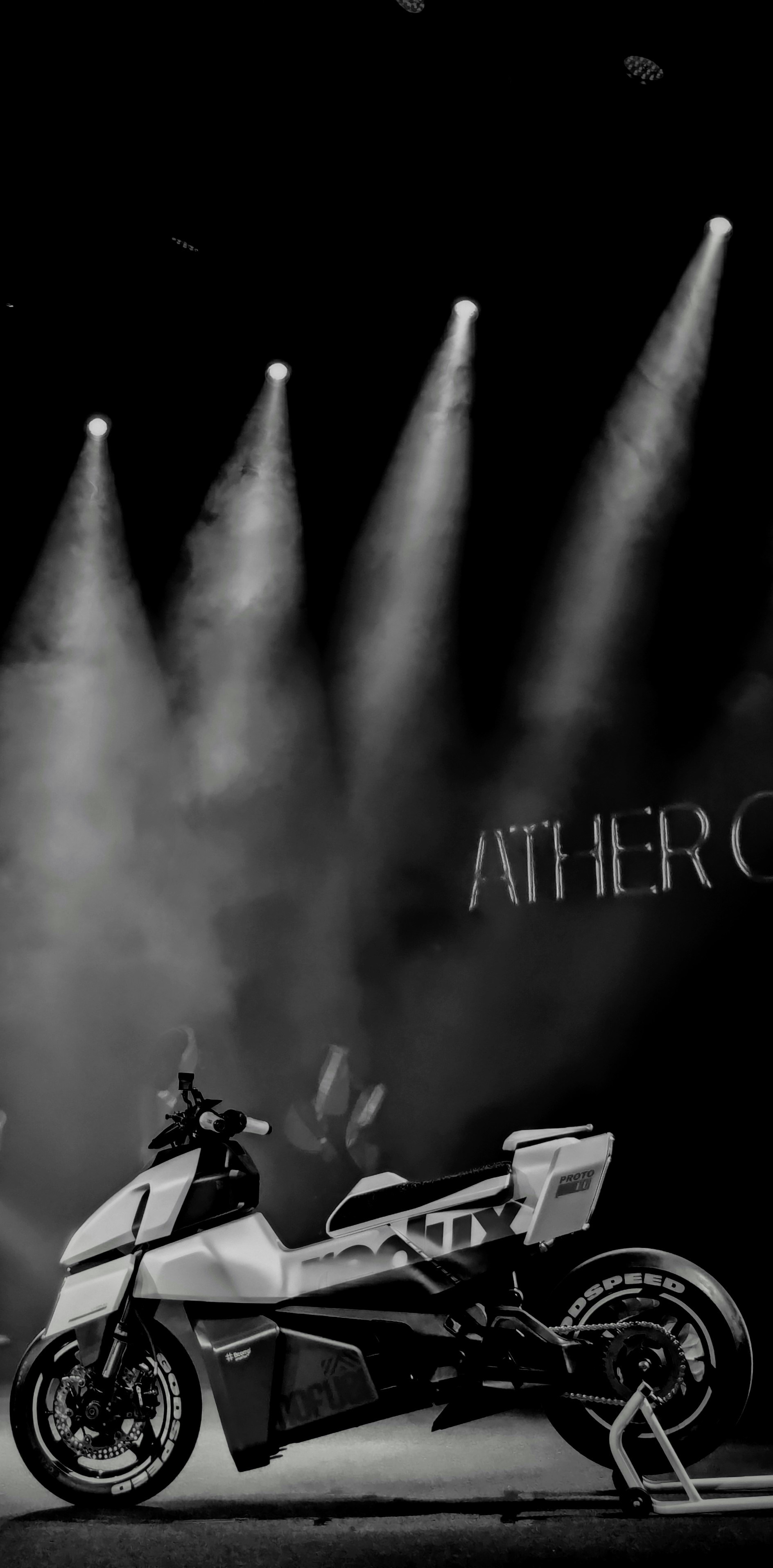 Ather Redux wallpaper | Modern electric scooter displayed under stage lights.