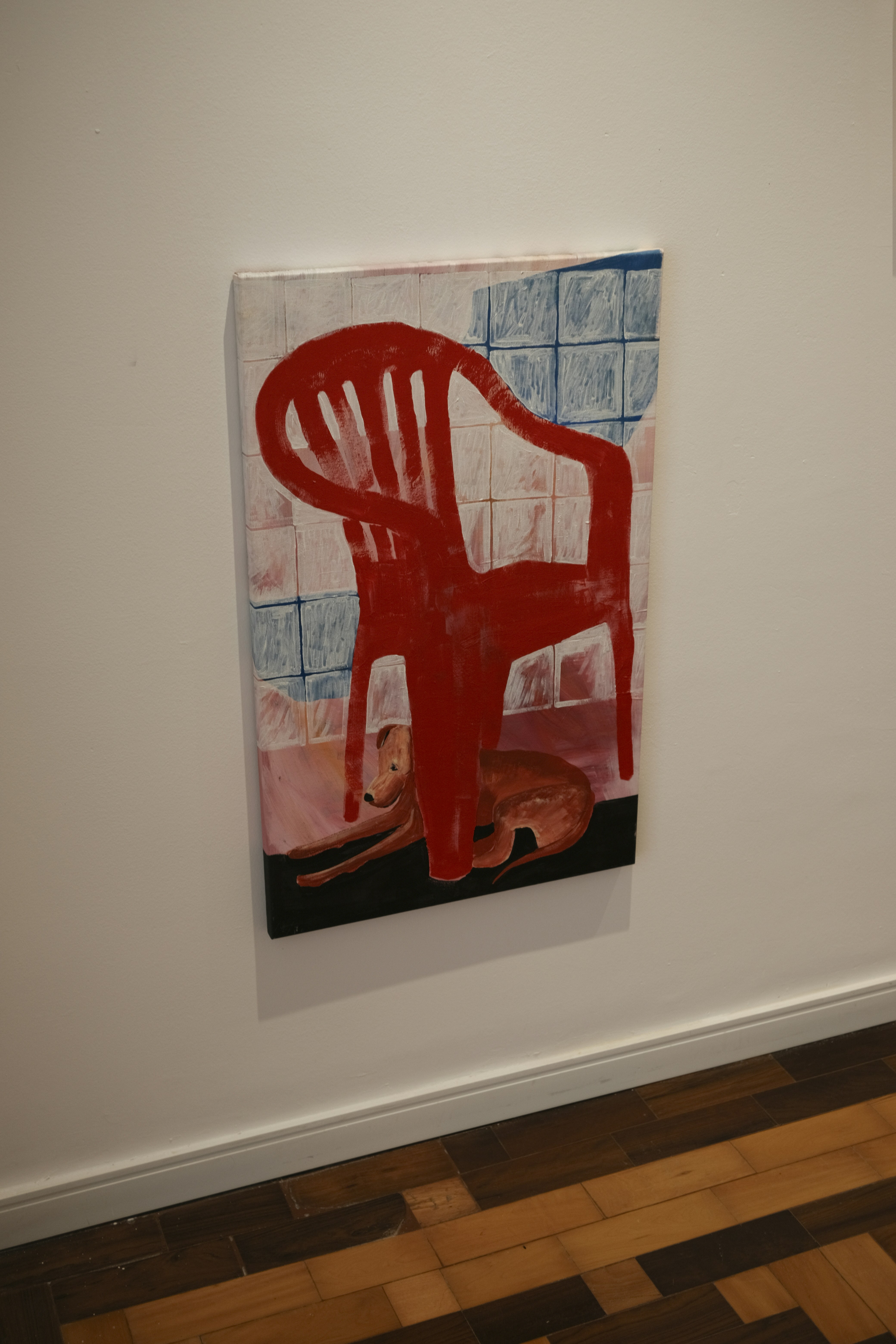 Red chair with a dog resting underneath