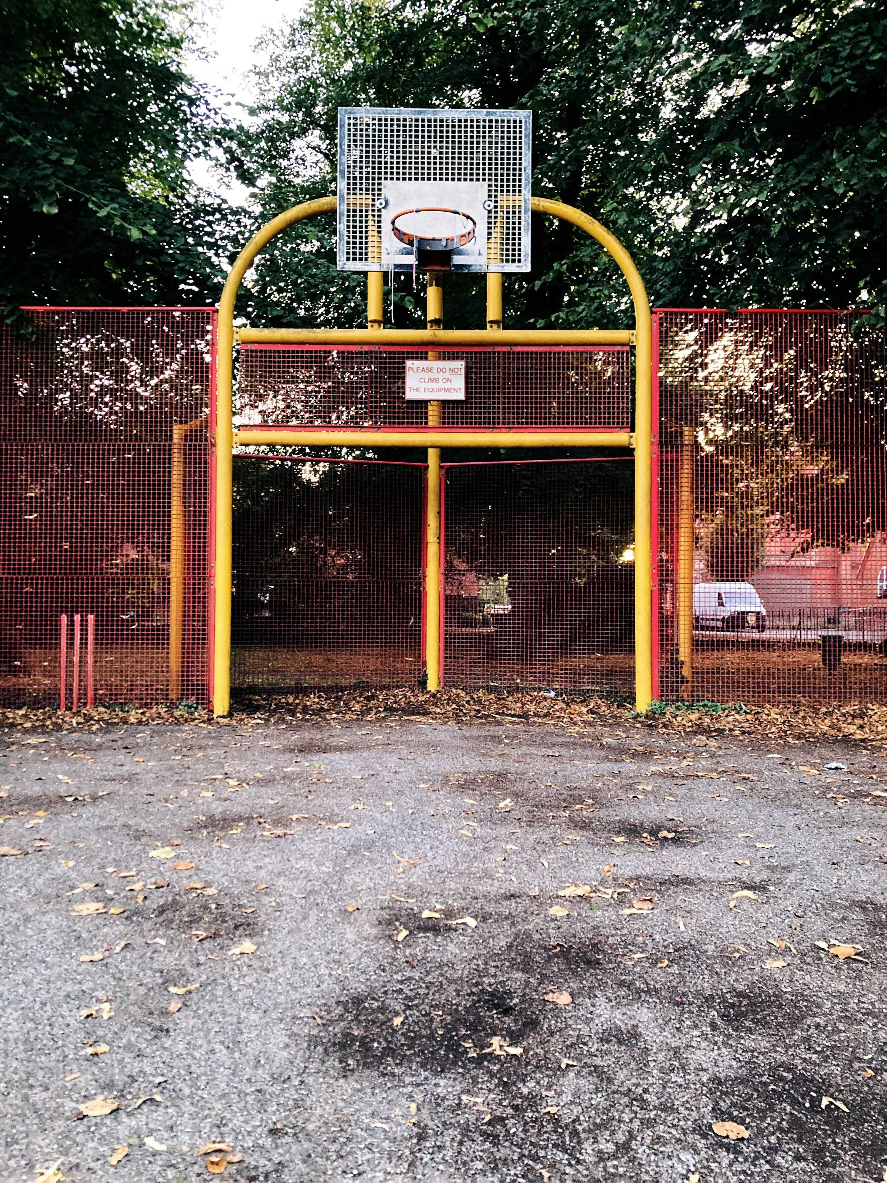 Outdoor basketball hoop with surrounding fence
