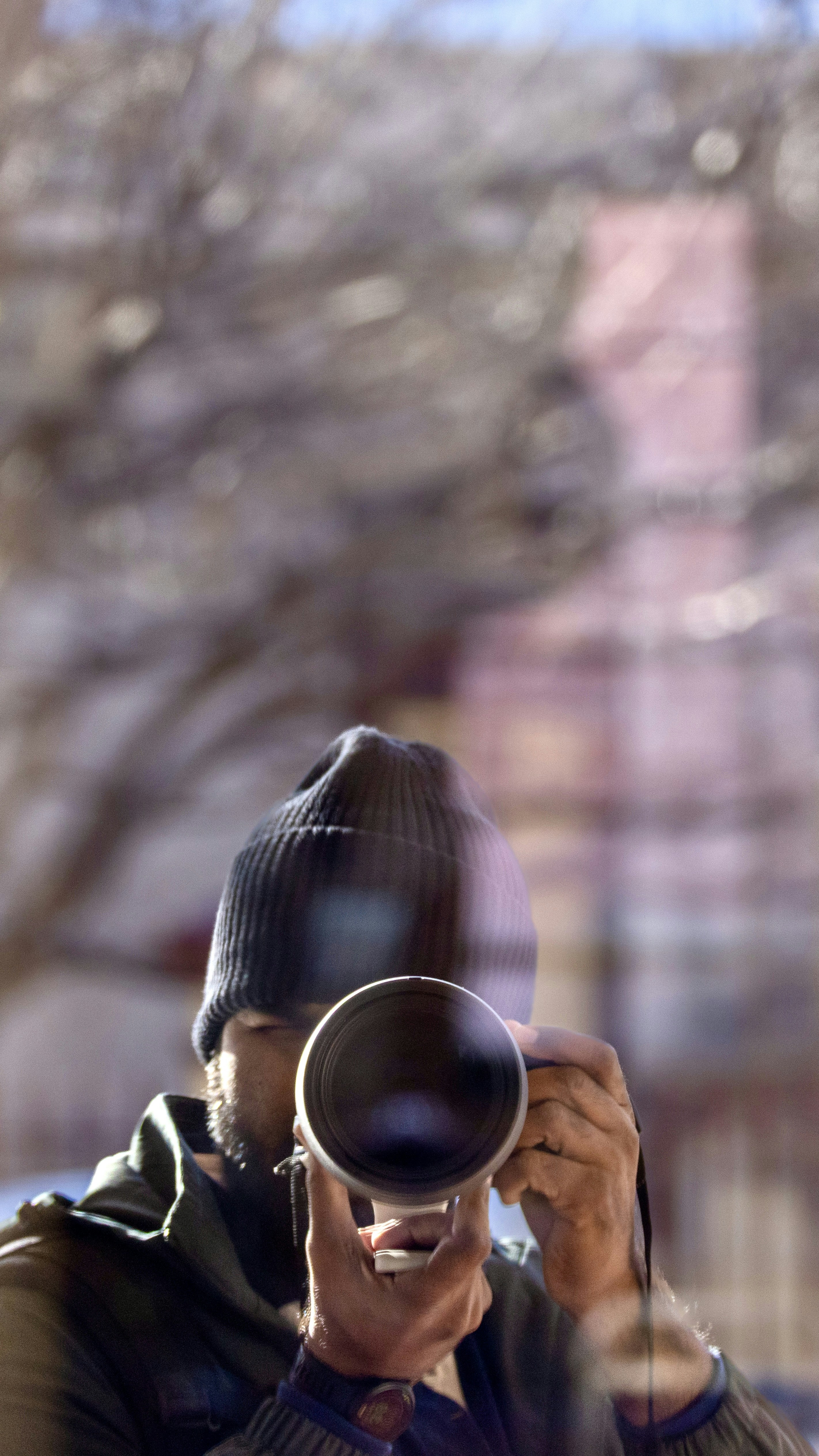 Through the Glass: A Street Portrait with a Telephoto Lens