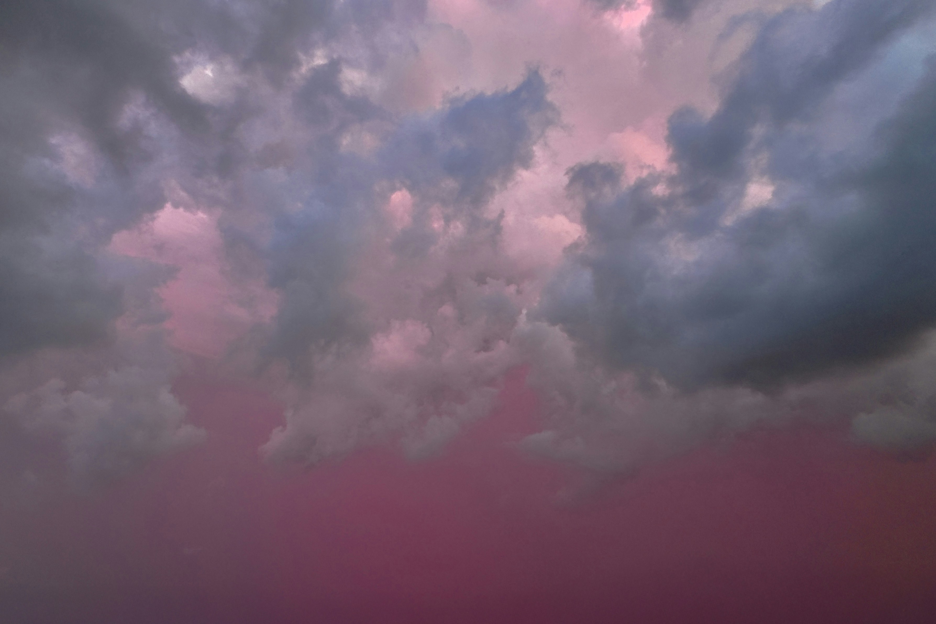 Dramatic pink and gray storm clouds at sunset