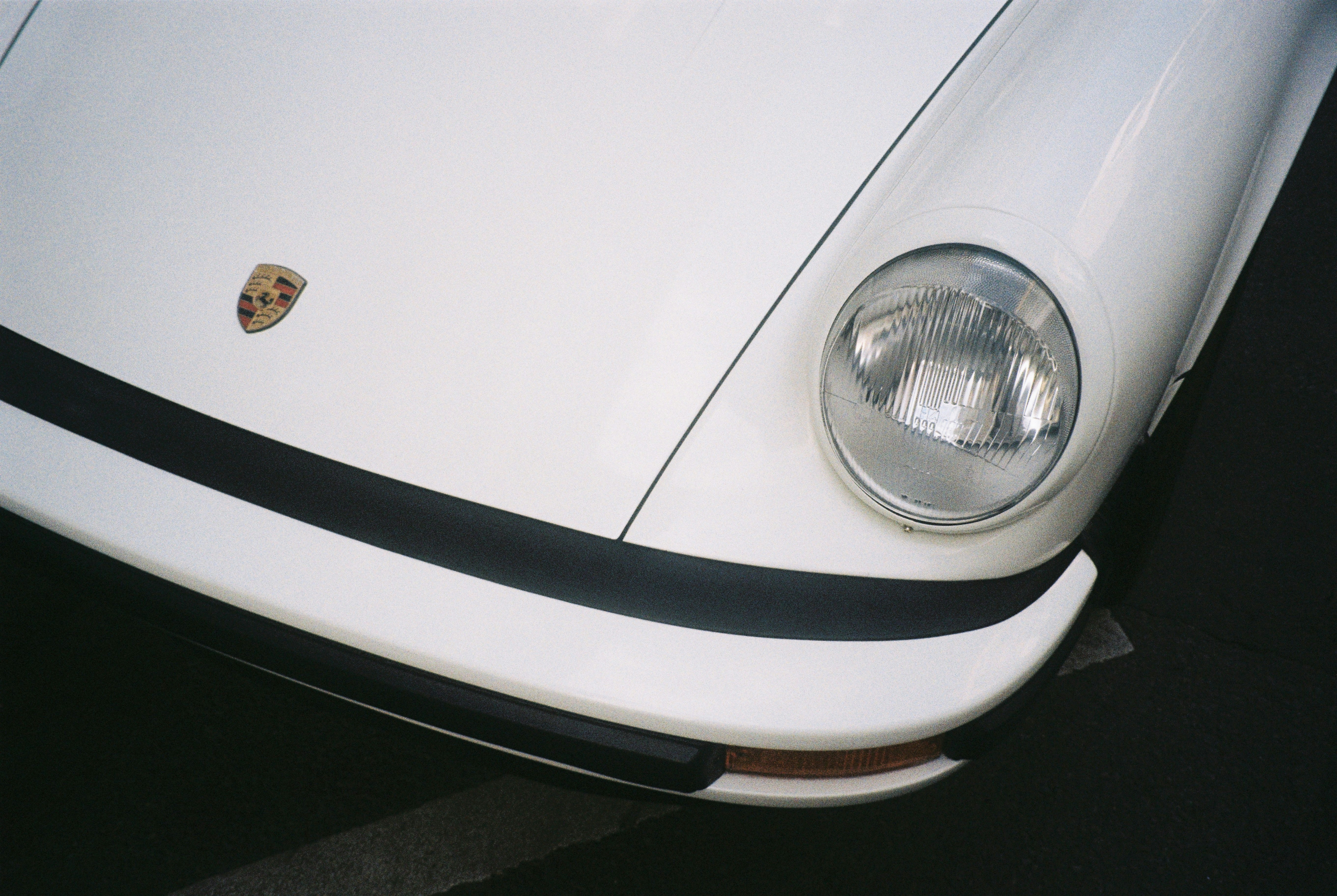 Shot on Kodak Gold 200 | Close-up of a white vintage car's front.