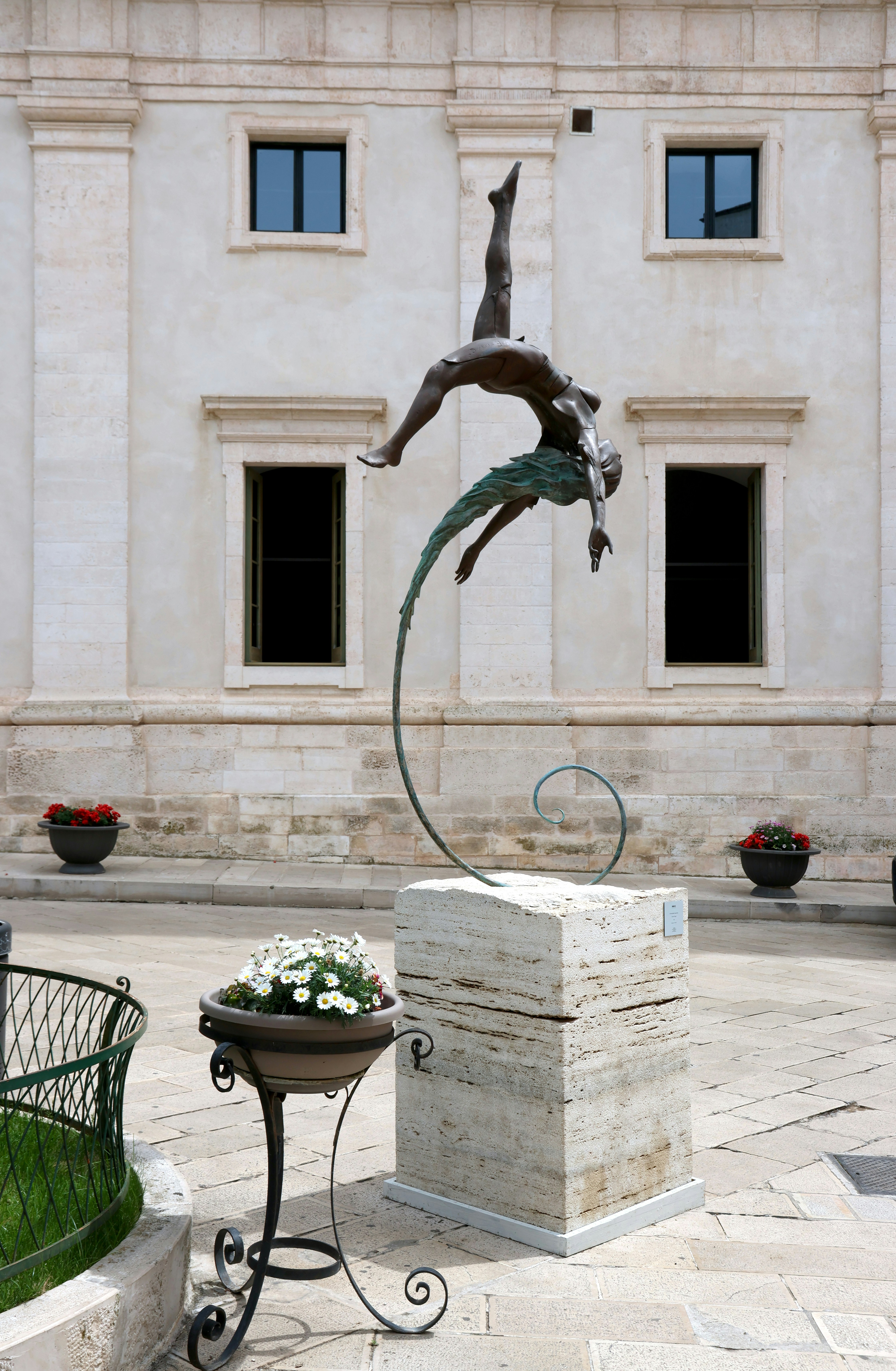 Spiral Leap: Bronze Dancer Arcing Above a Marble Pedestal