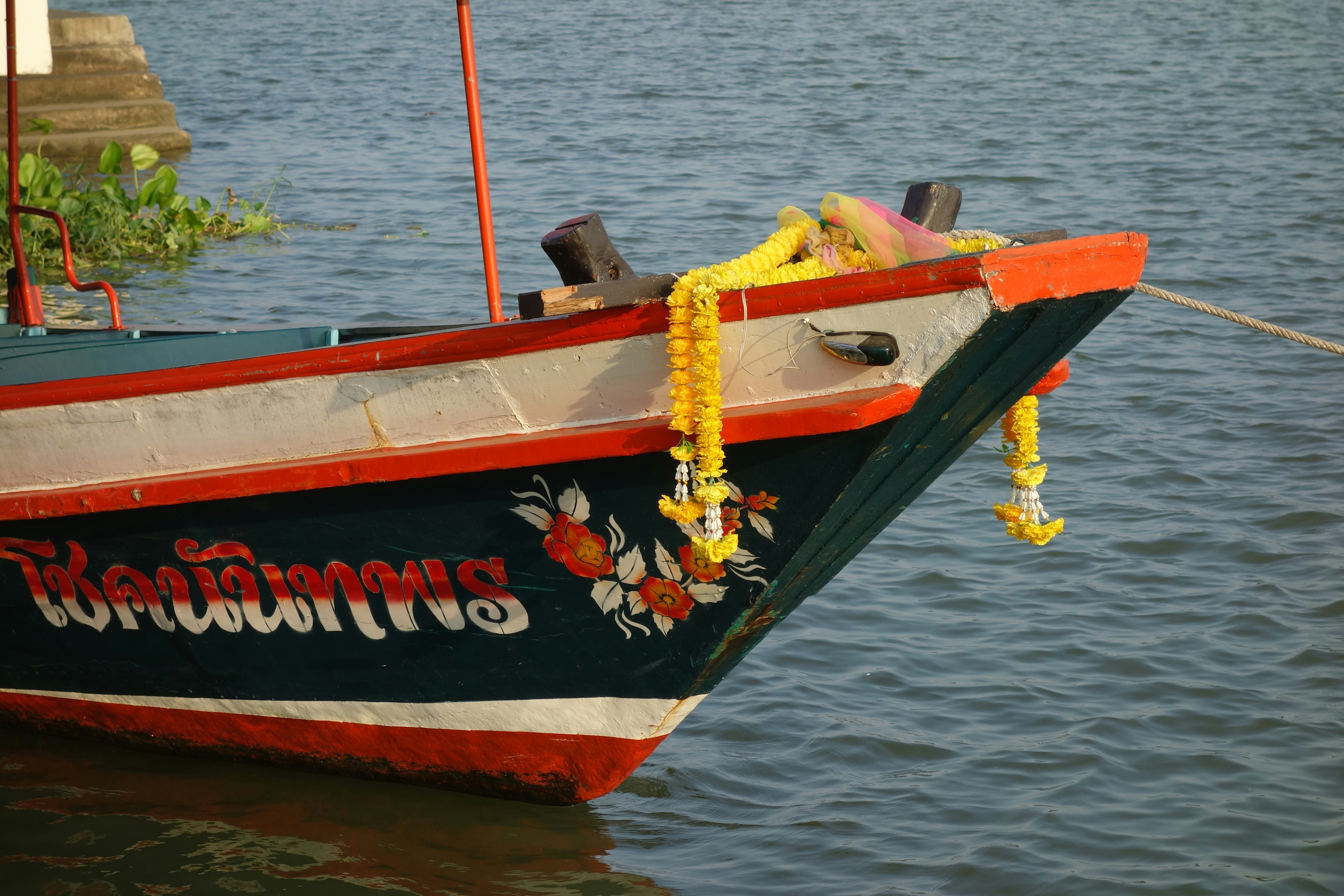 A decorated boat with floral designs on the side.