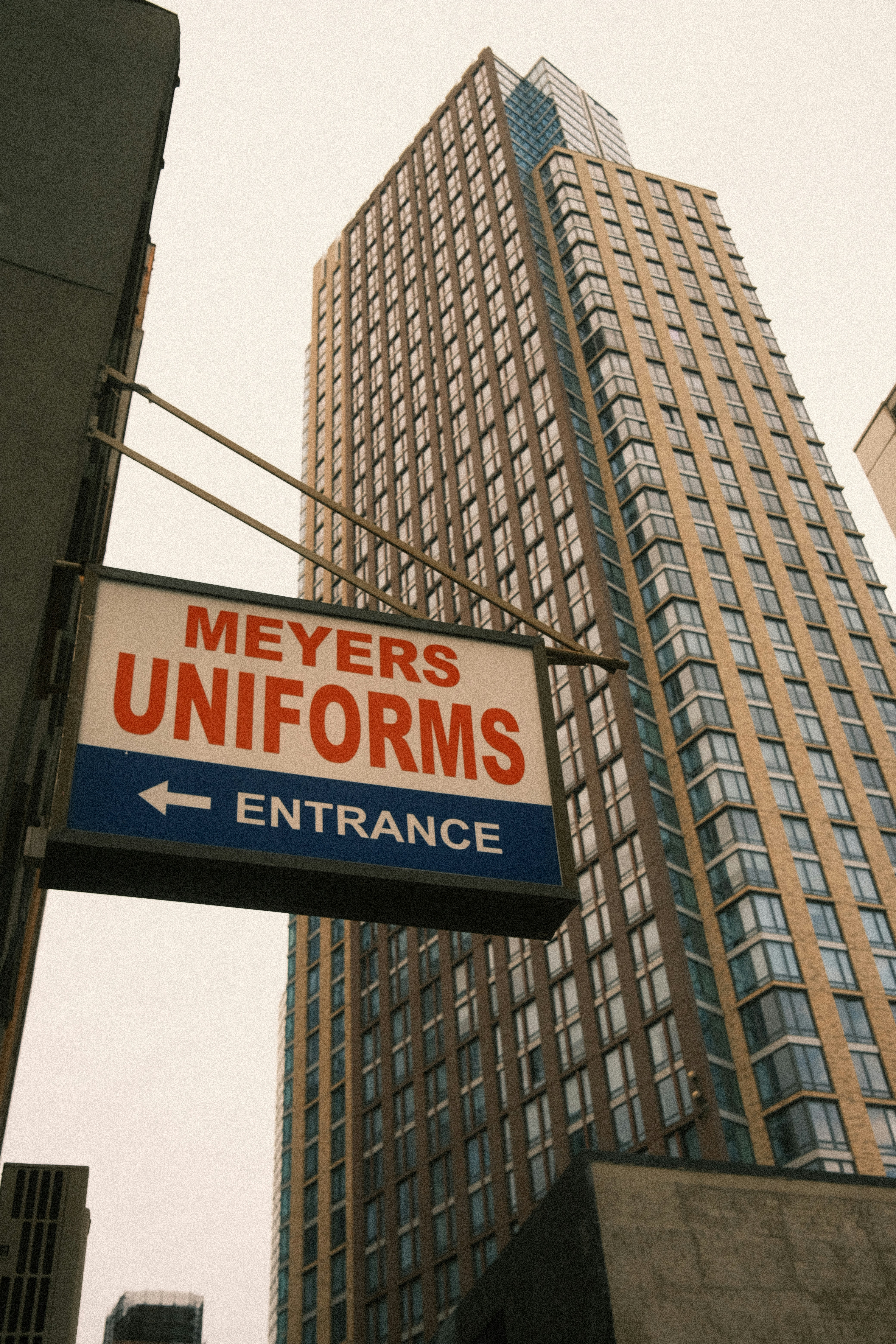 Meyers uniforms entrance sign with tall building photo – Free Image on ...