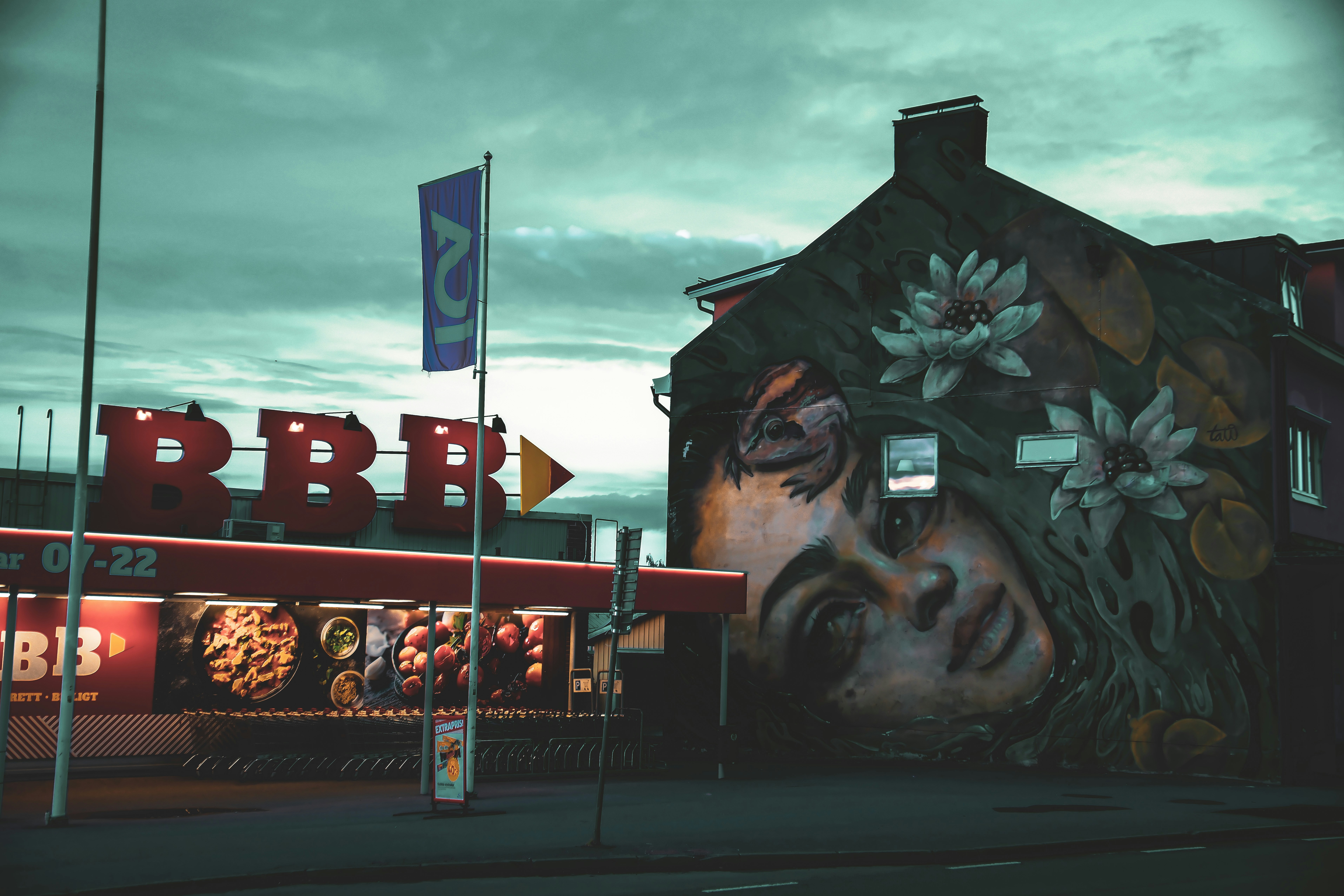 Building with large mural and supermarket sign at a store