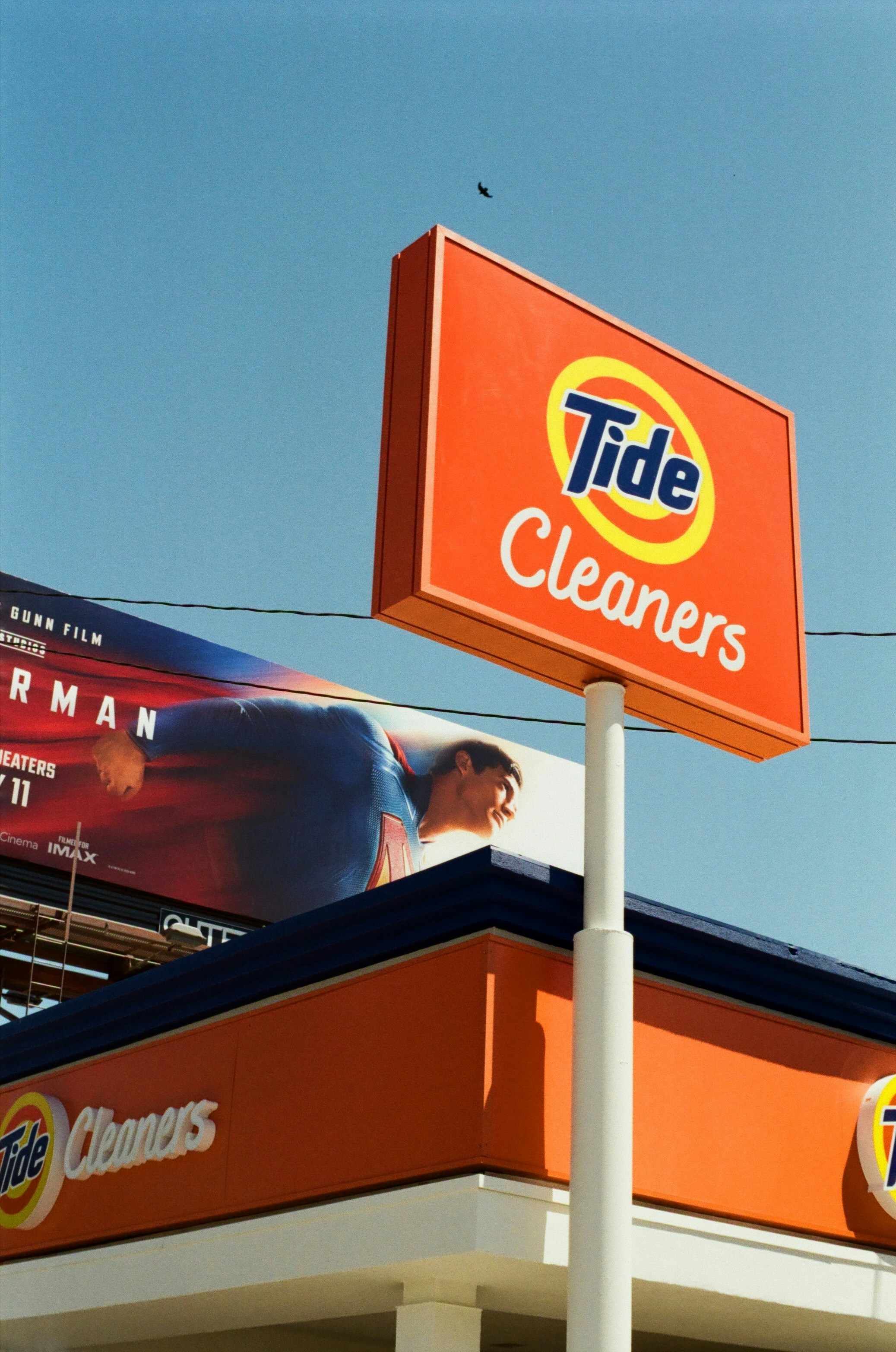 Tide cleaners sign with superman billboard behind. photo – Free ...